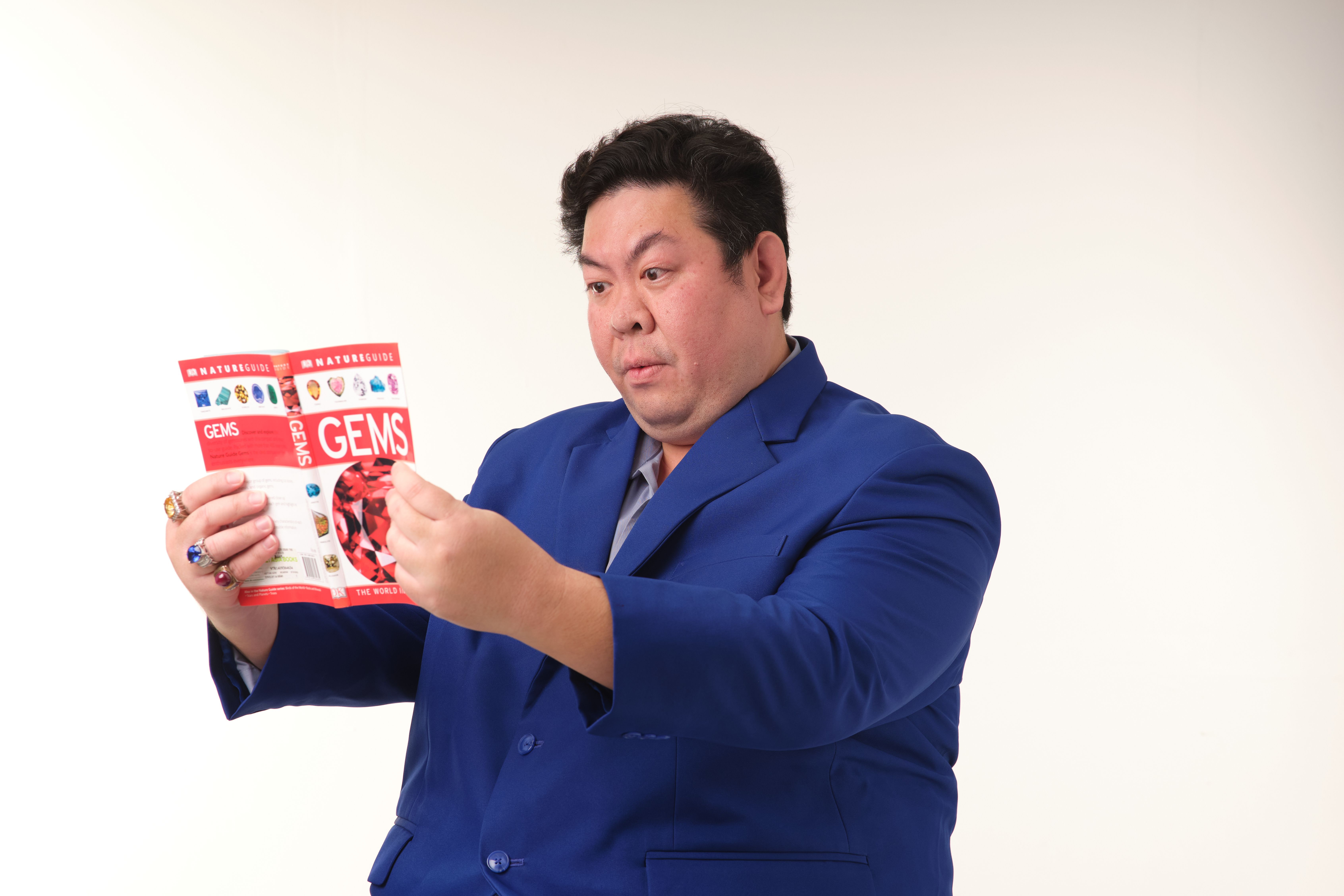 Man Reading Gems Book in Blue Suit · Free Stock Photo