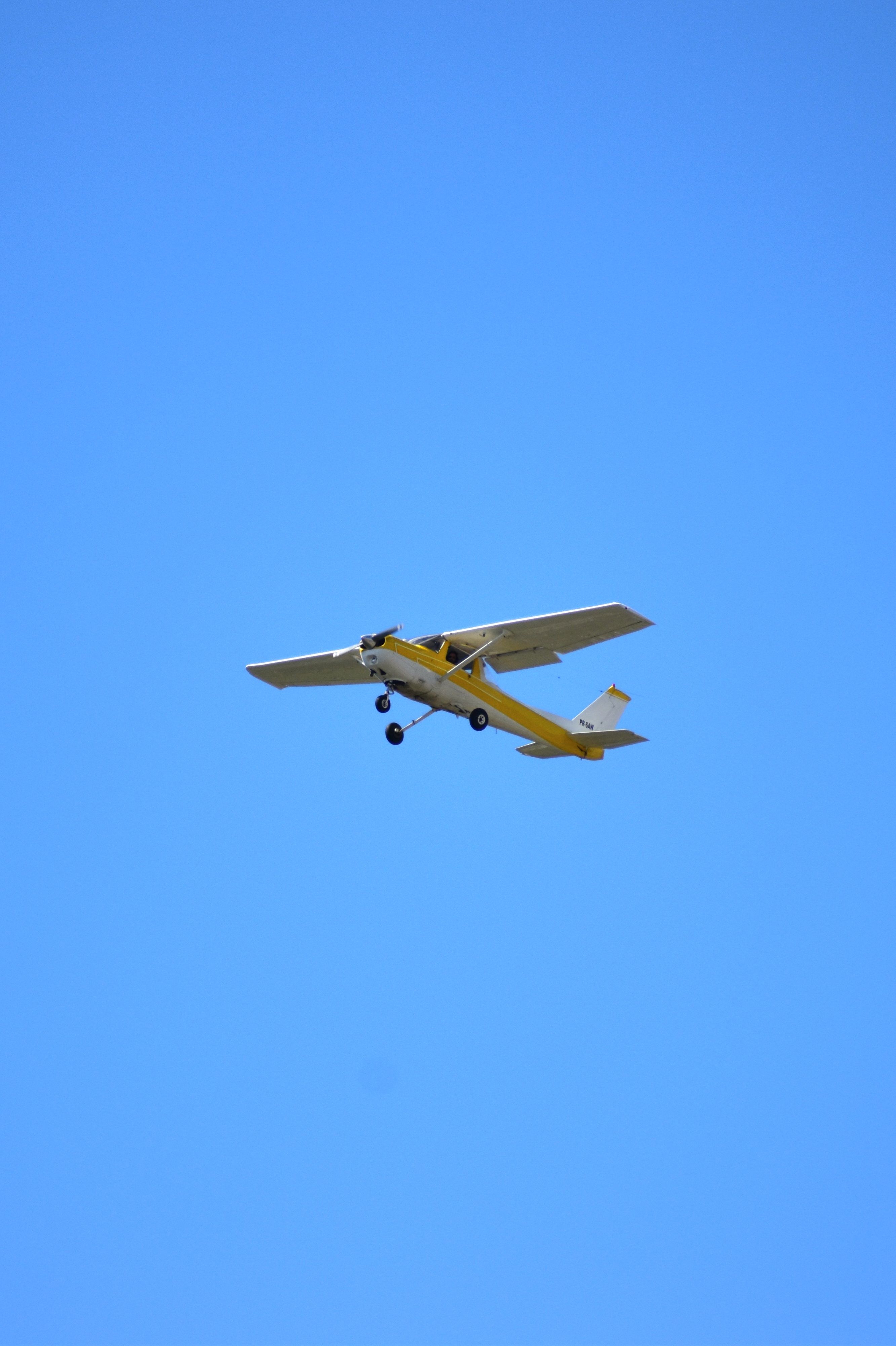 Bright Yellow Airplane in Clear Blue Sky · Free Stock Photo