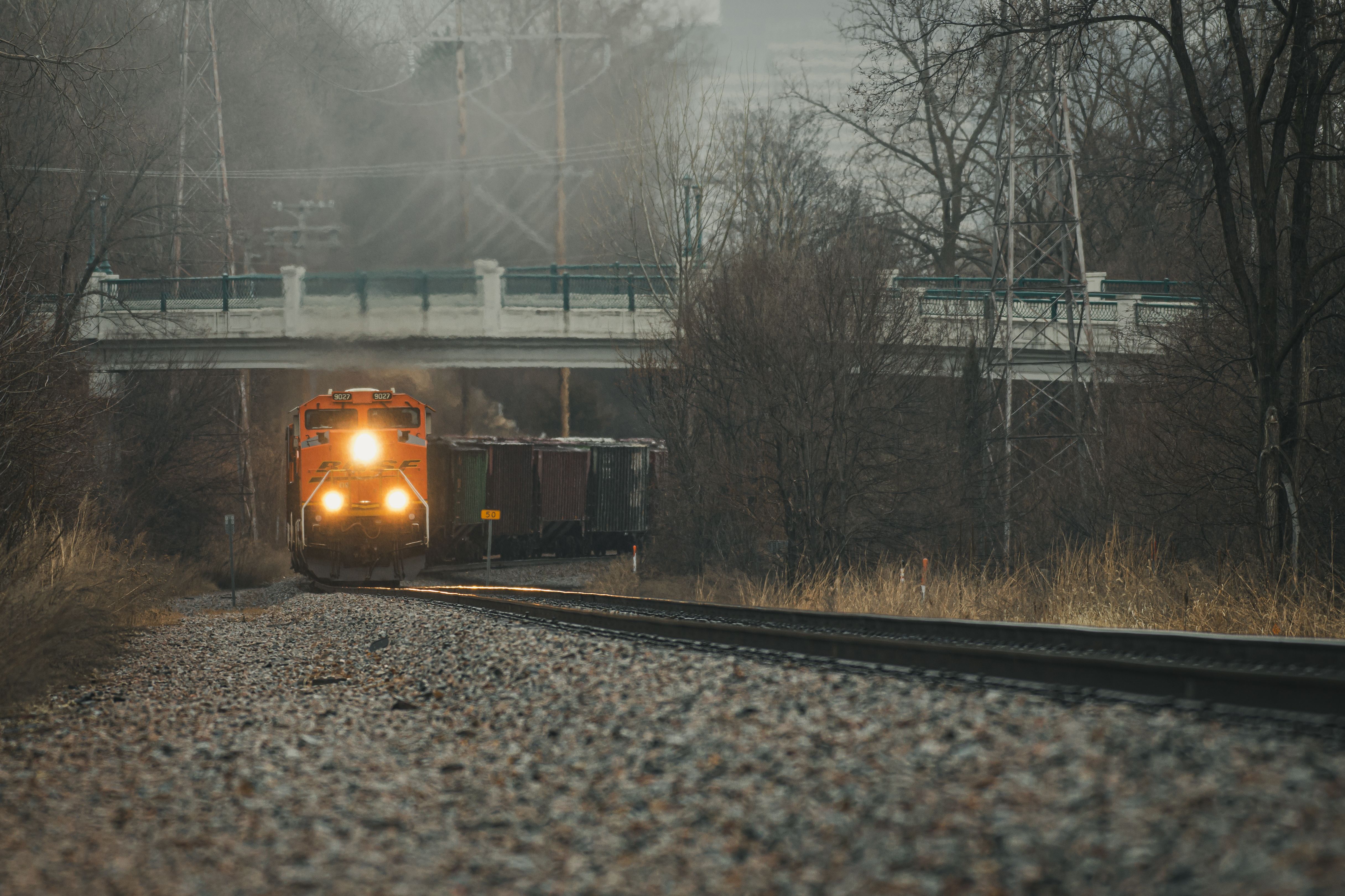 Freight Train Approaching Under Bridge · Free Stock Photo