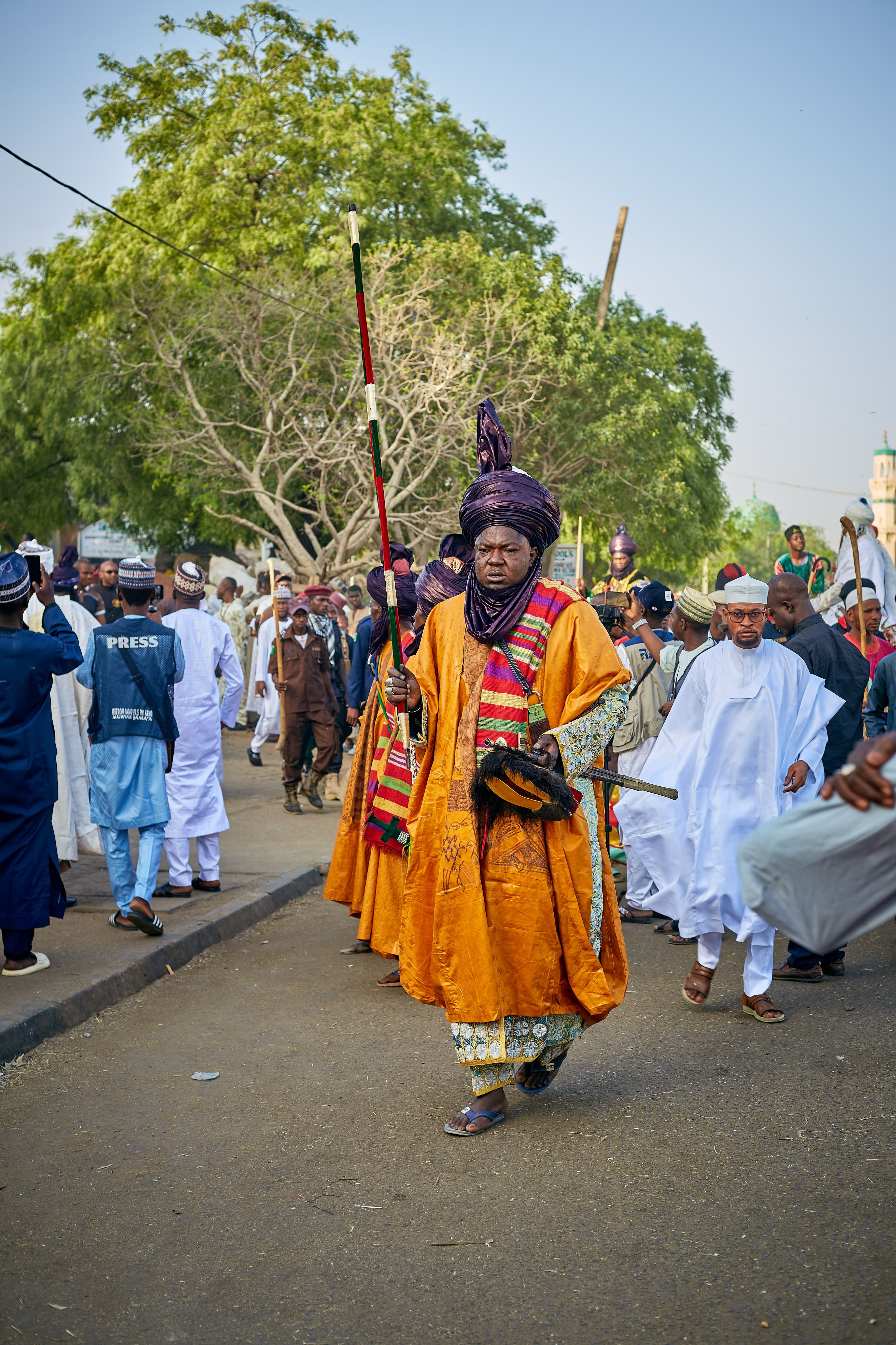 Traditional Parade with Cultural Attire in Street · Free Stock Photo