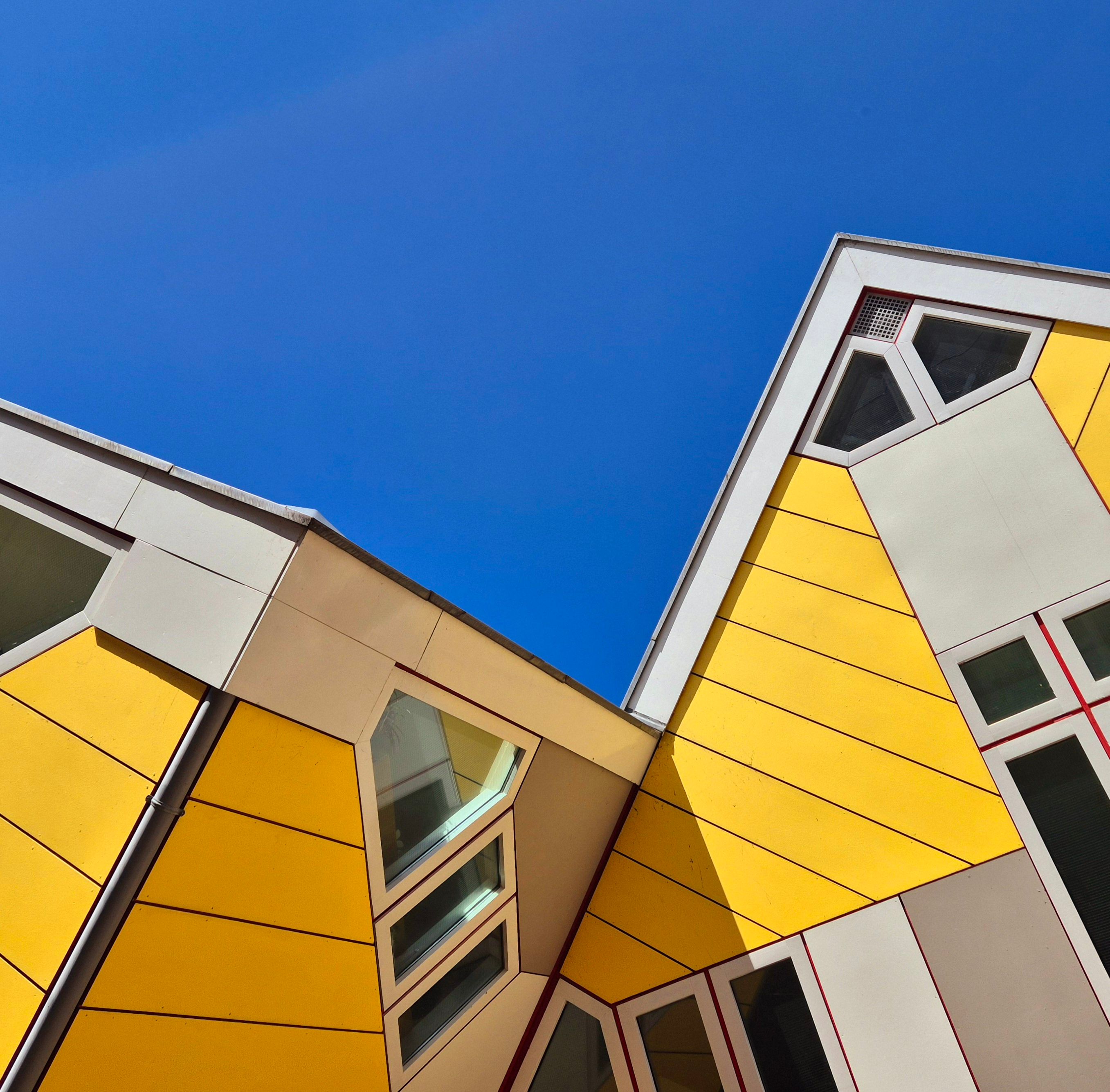 Modern Architectural Yellow Cube Houses Against Blue Sky · Free Stock Photo