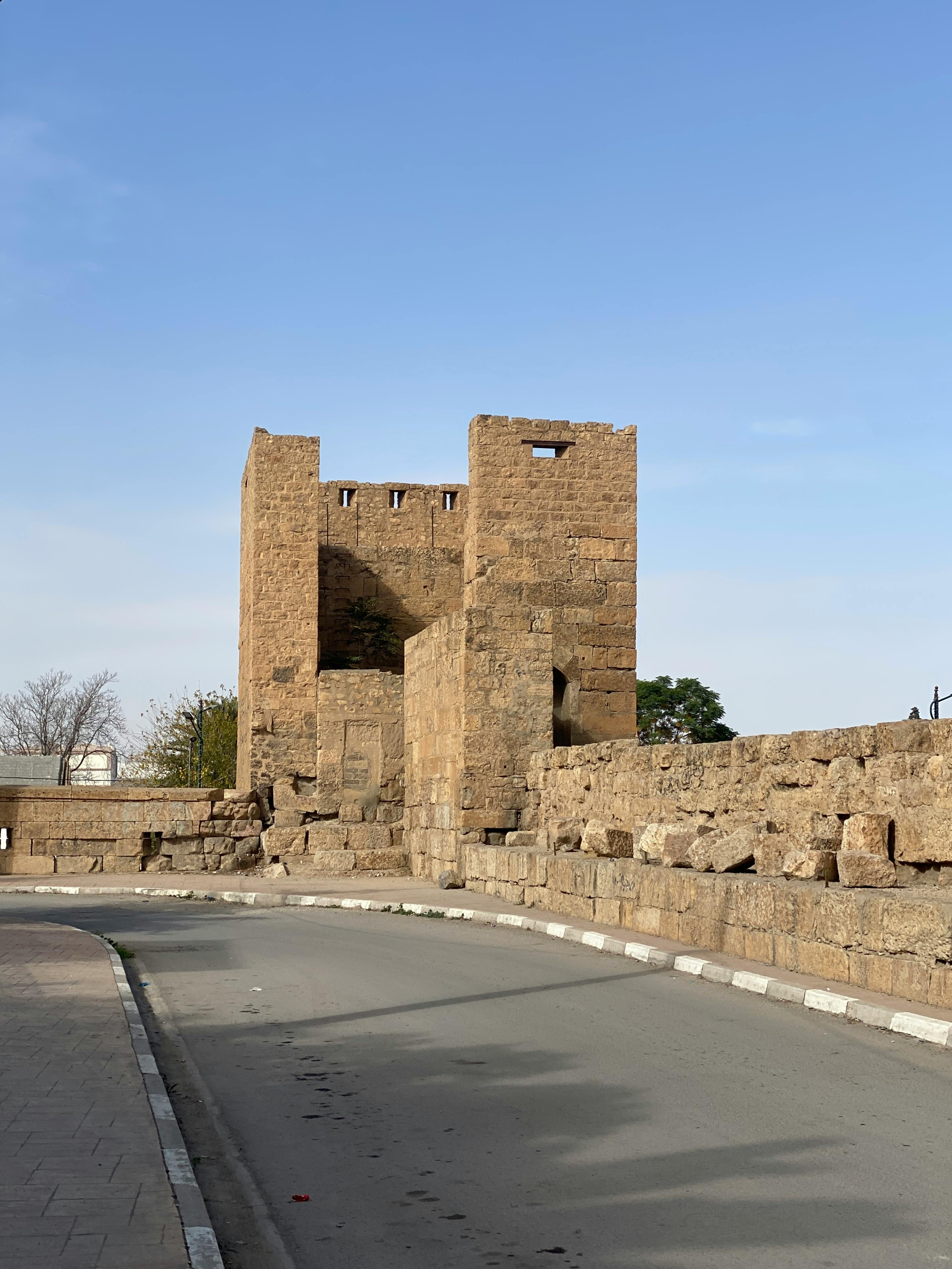Ancient Fortification in Sunlit Urban Setting · Free Stock Photo
