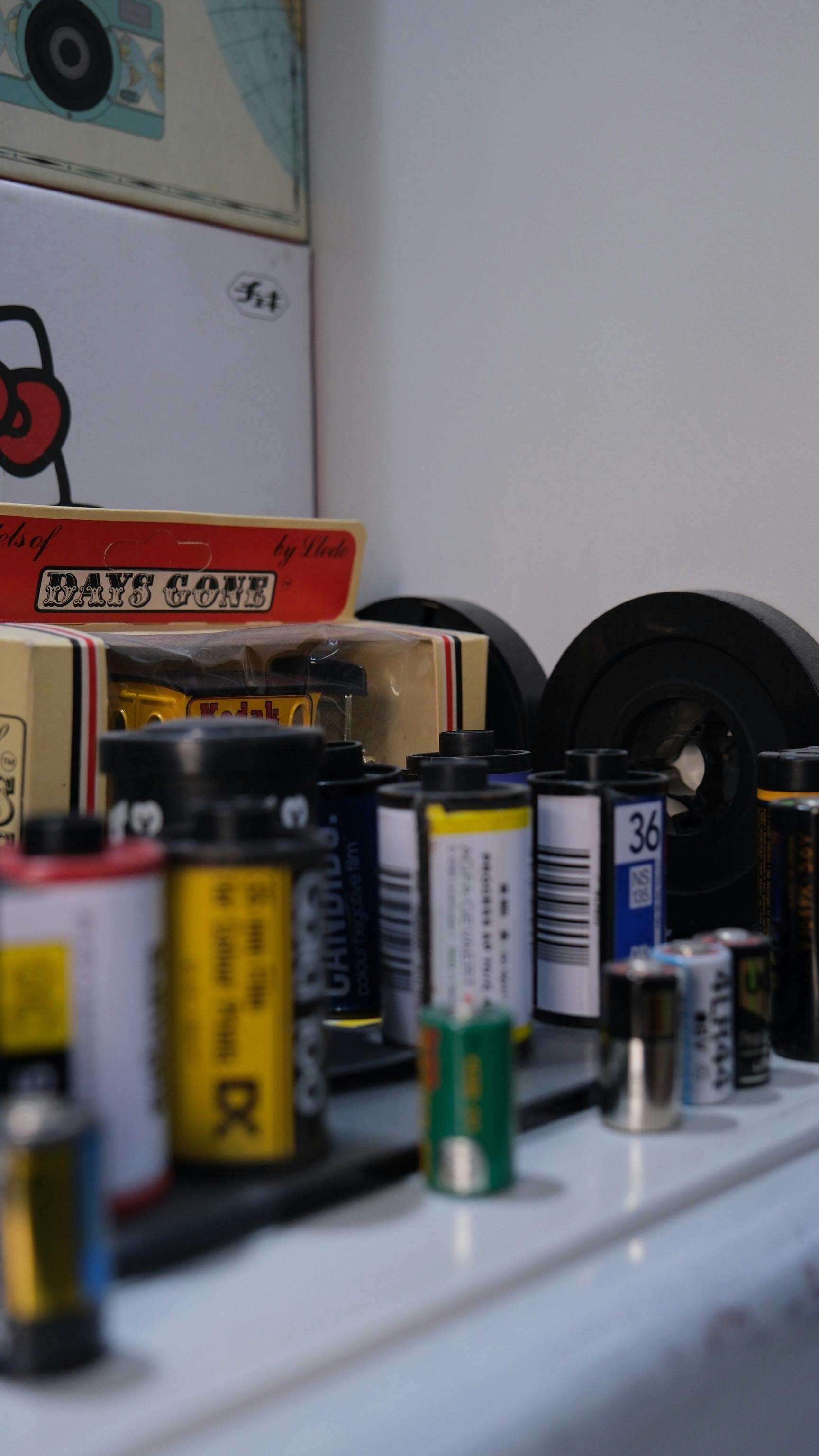 Assorted Film Rolls and Vintage Camera Gear · Free Stock Photo