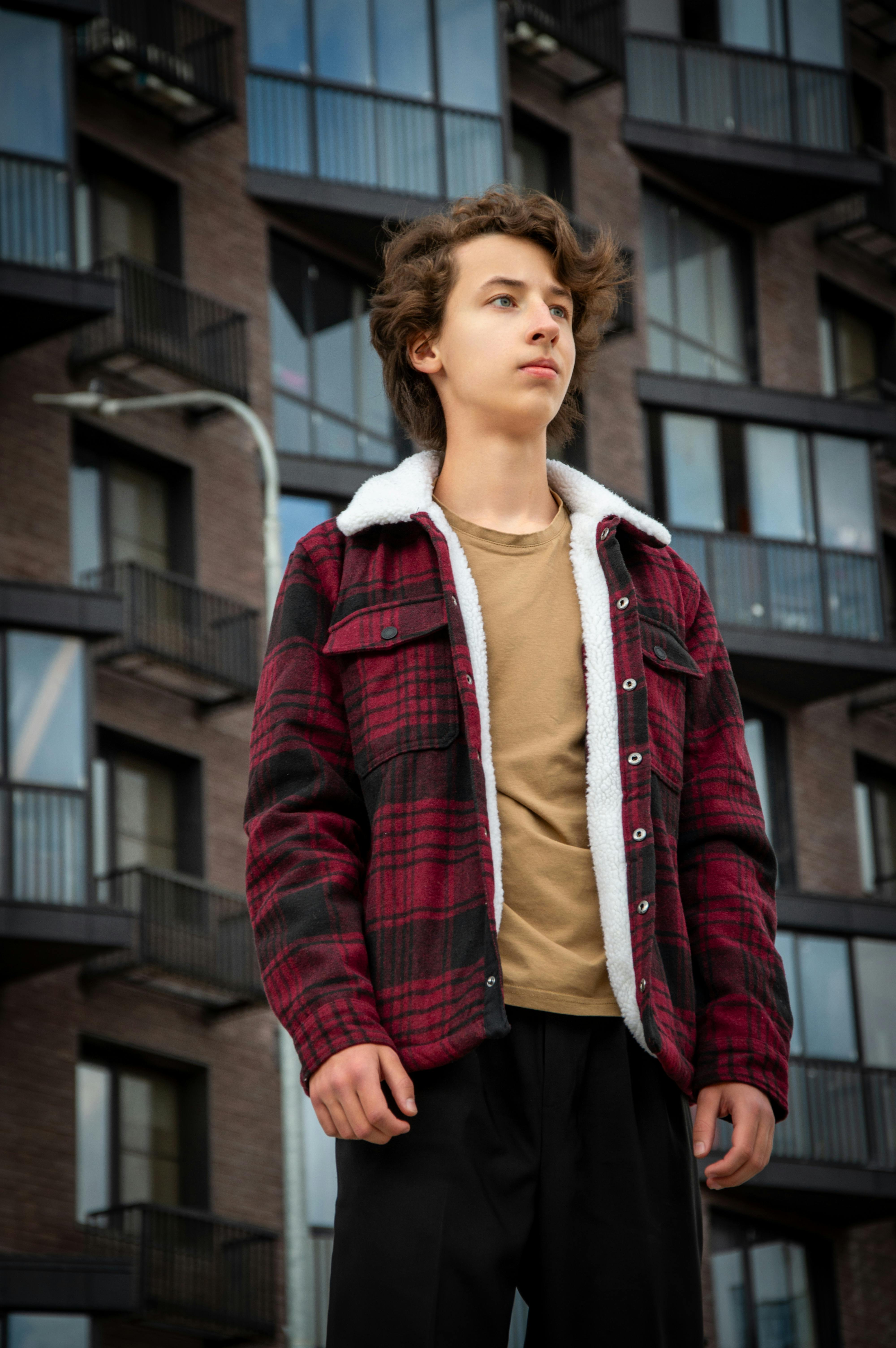 Teenager standing confidently with urban backdrop · Free Stock Photo