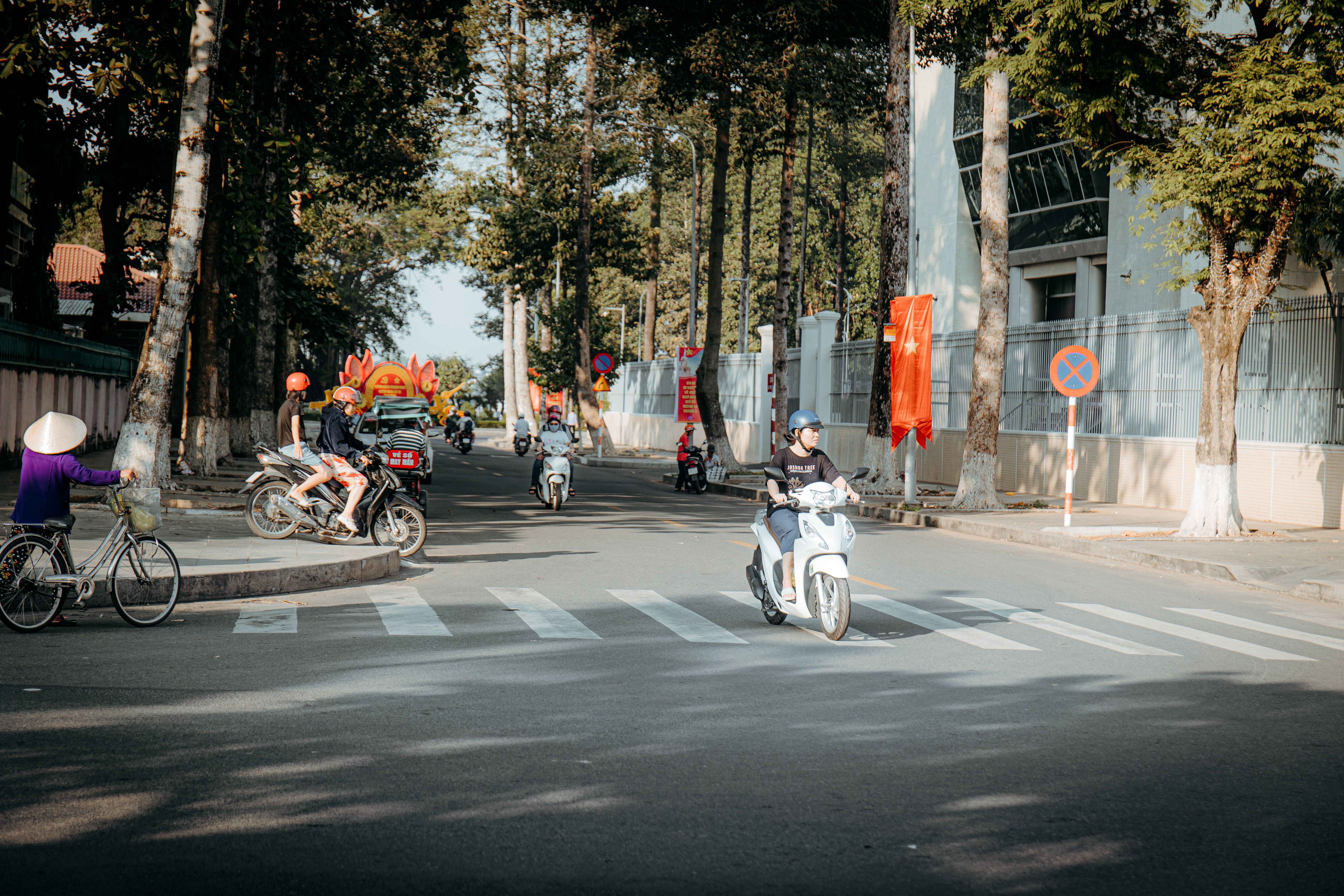 Urban Street Scene with Motorbikes and Cyclists · Free Stock Photo