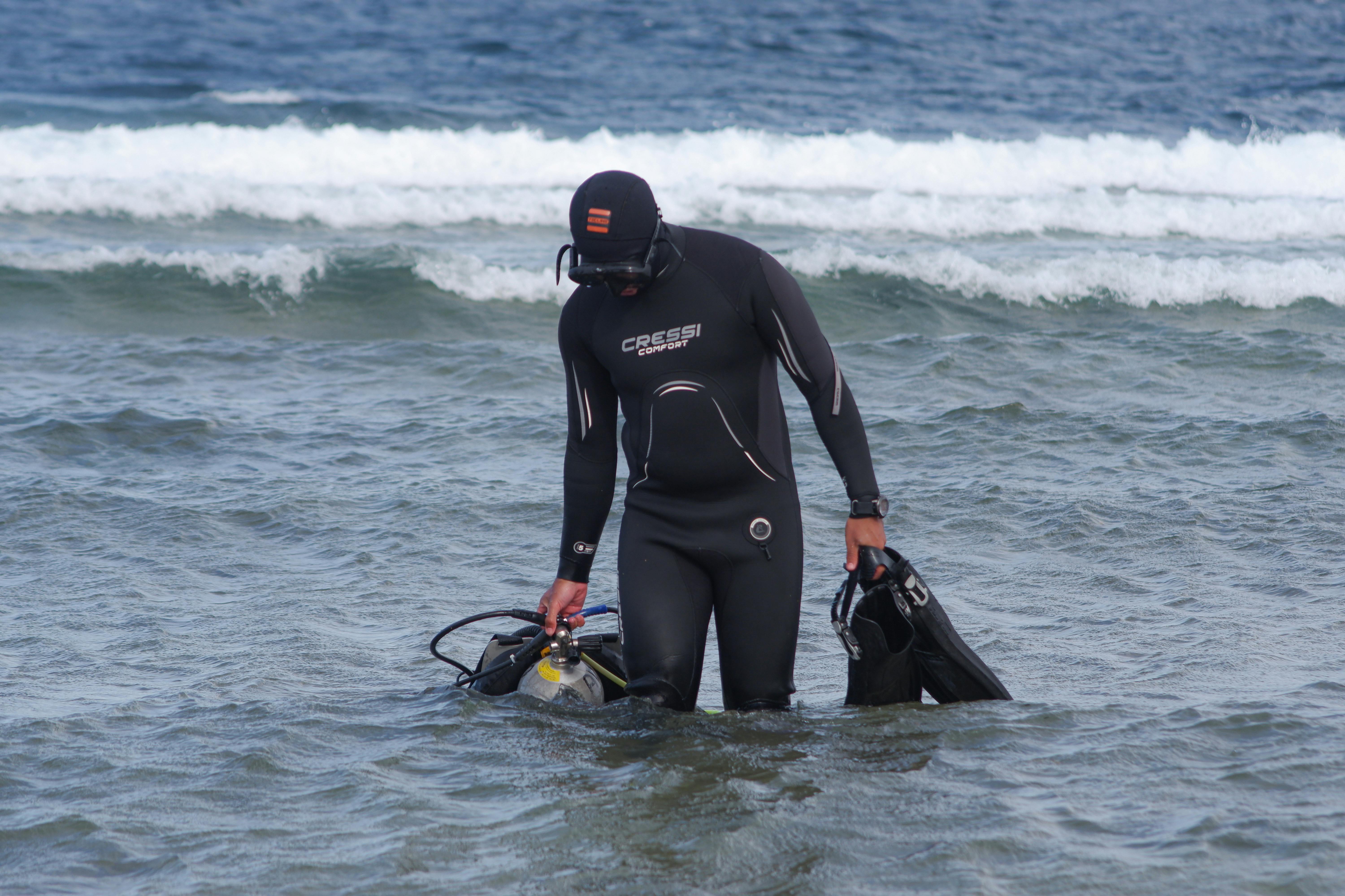 Scuba Diver Emerging from Ocean Waves · Free Stock Photo