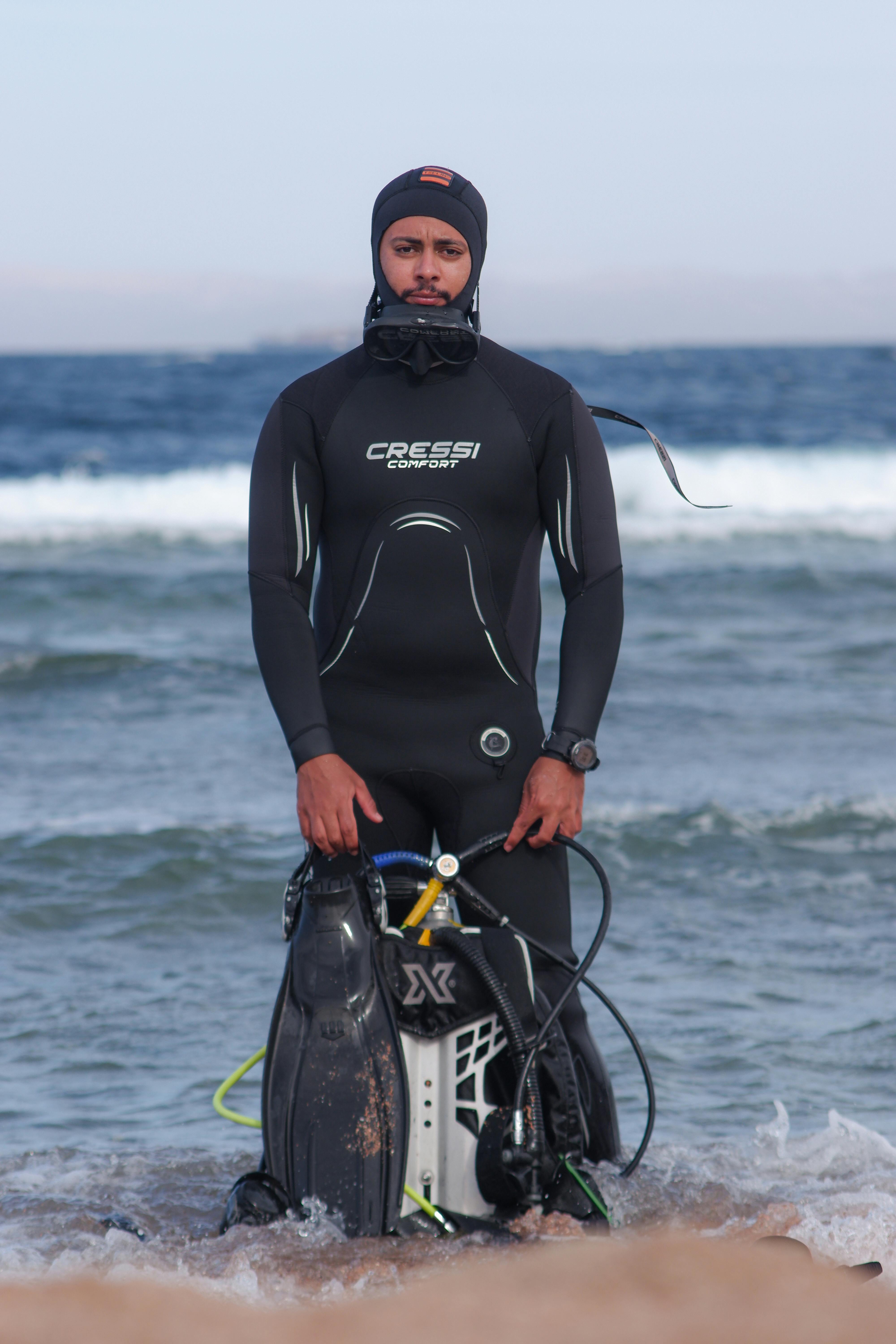 Scuba Diver Standing on Shoreline Preparing to Dive · Free Stock Photo