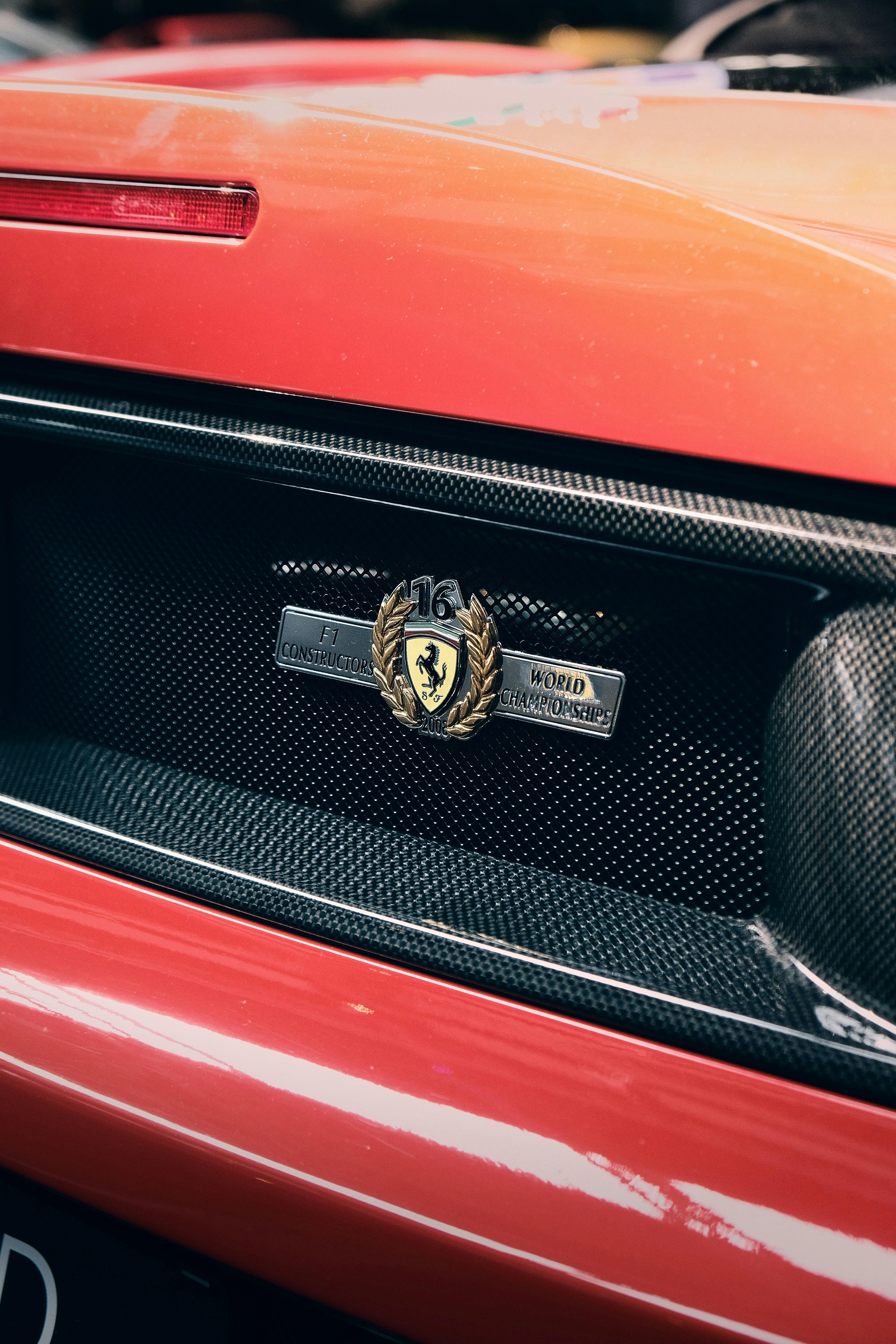 Close-Up of Ferrari Rear Badge on Red Supercar · Free Stock Photo