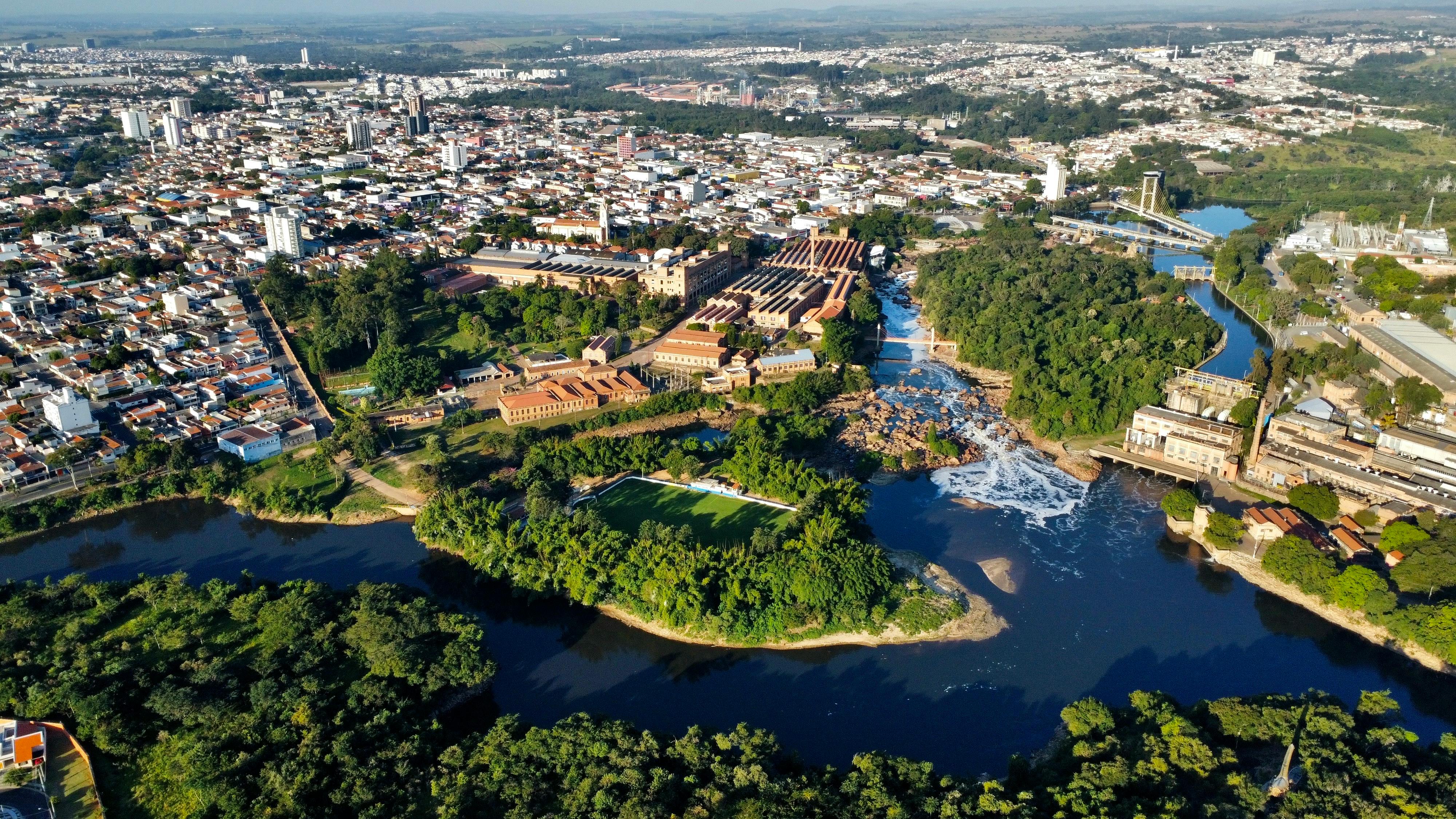 Aerial View of City with River and Greenery · Free Stock Photo