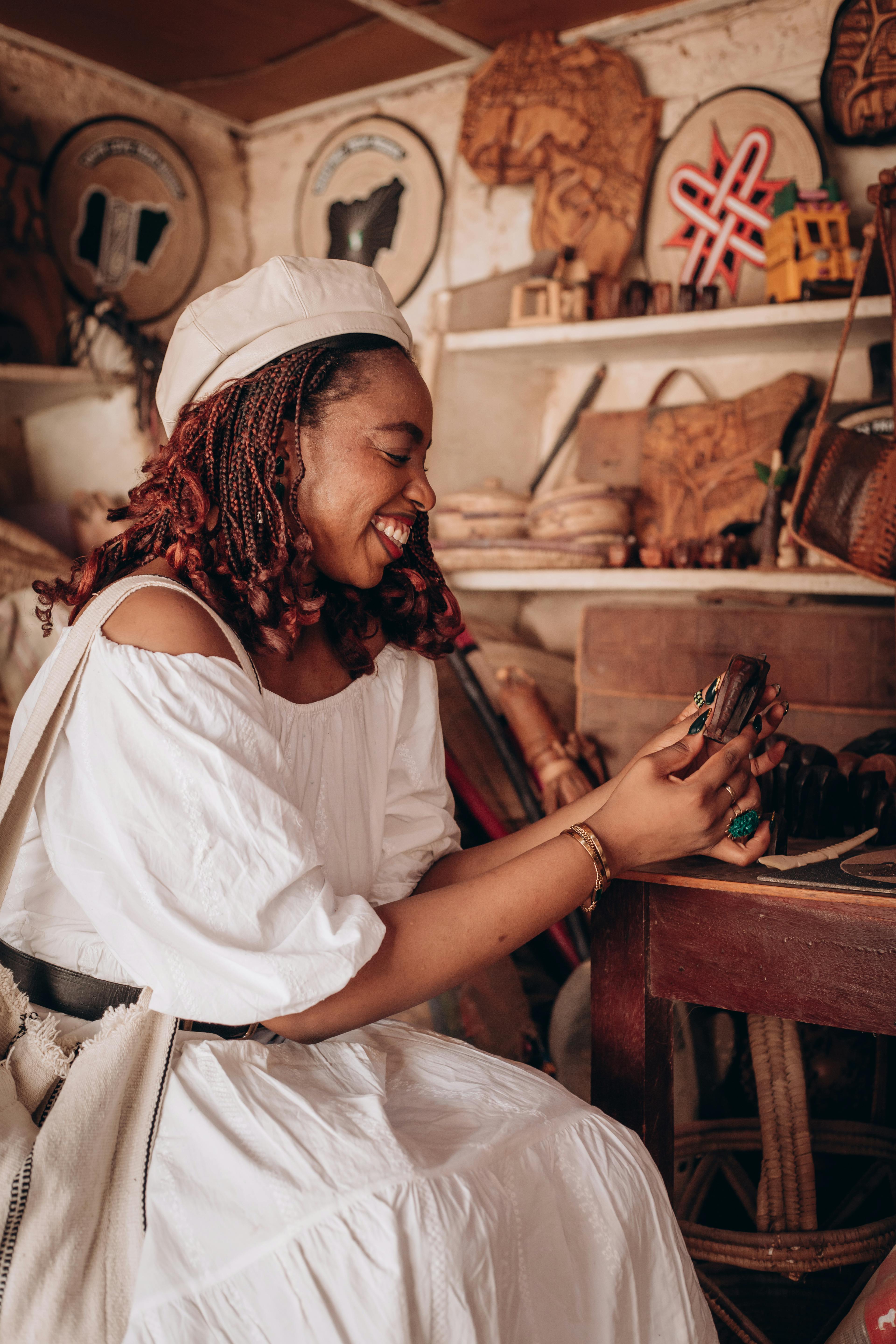 Cultural Artisan Enjoying Craftwork in Nigerian Workshop · Free Stock Photo
