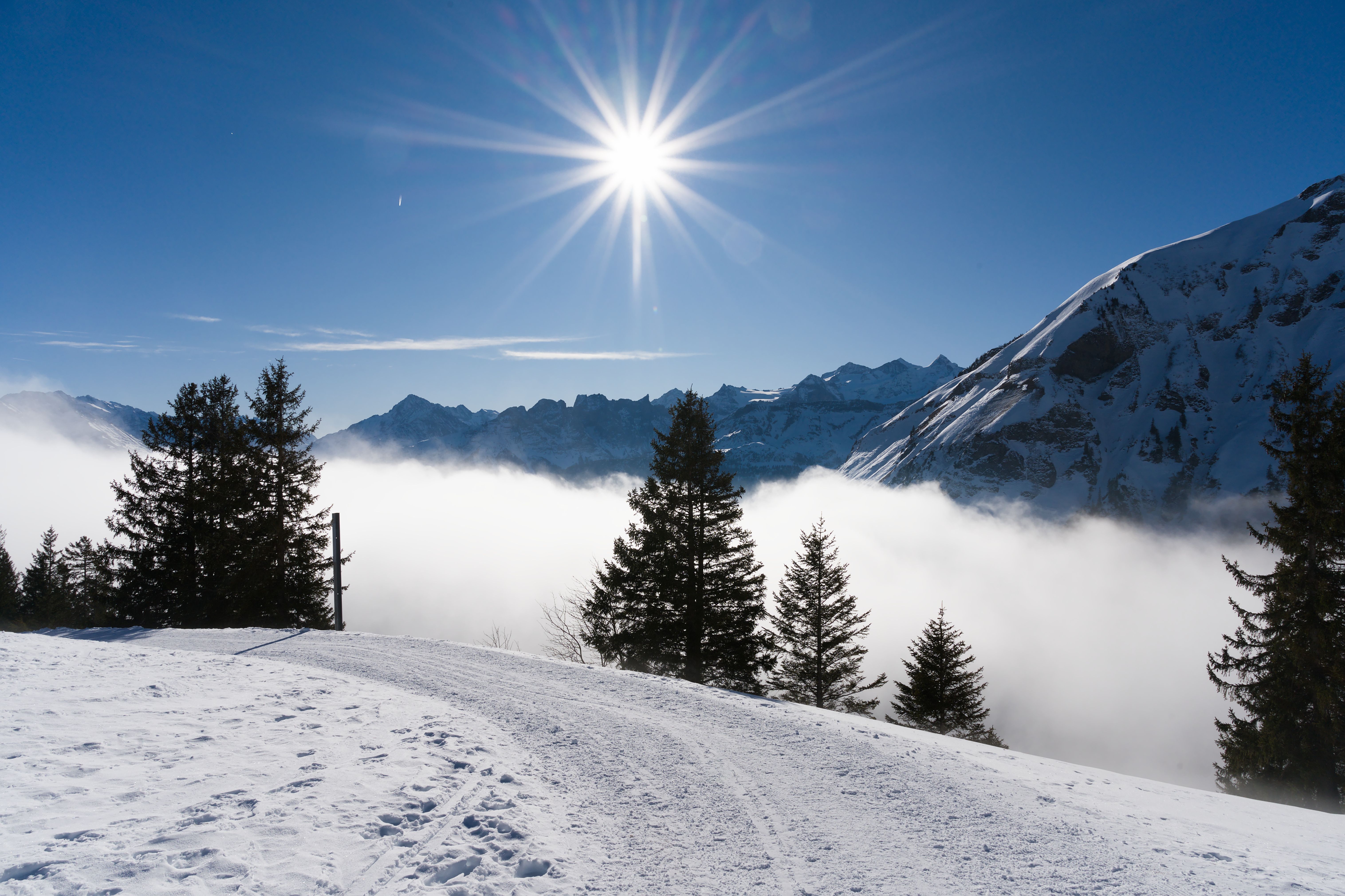 Snowy Swiss Alps Landscape with Bright Sun · Free Stock Photo