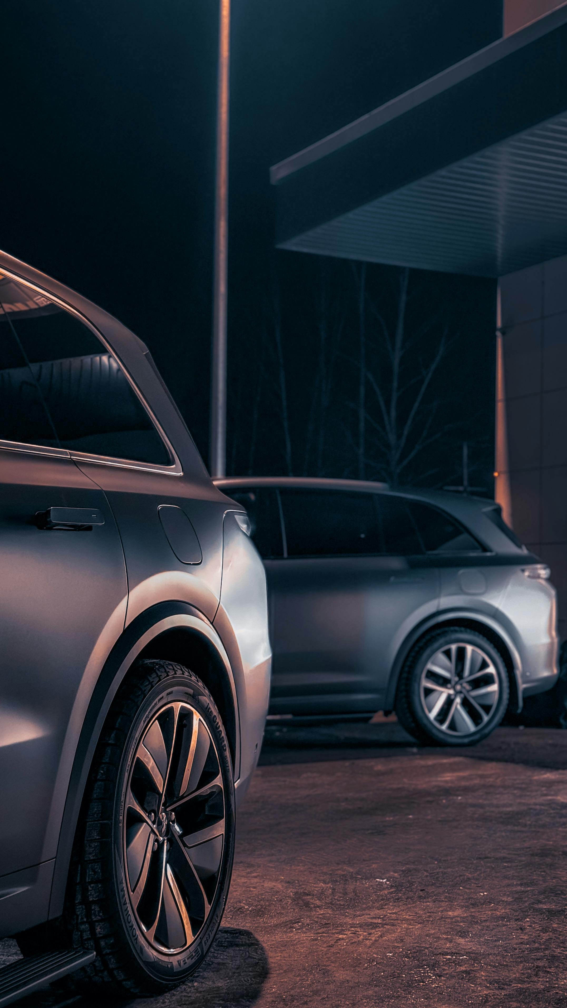 Sleek Silver Cars at Night in Urban Setting · Free Stock Photo