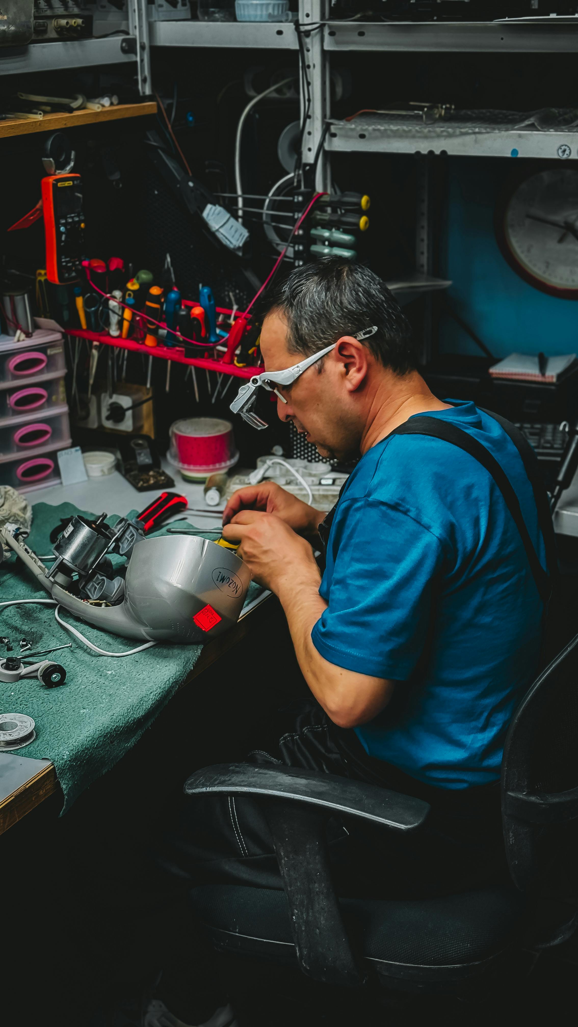 Skilled Technician Repairing Device in Workshop · Free Stock Photo
