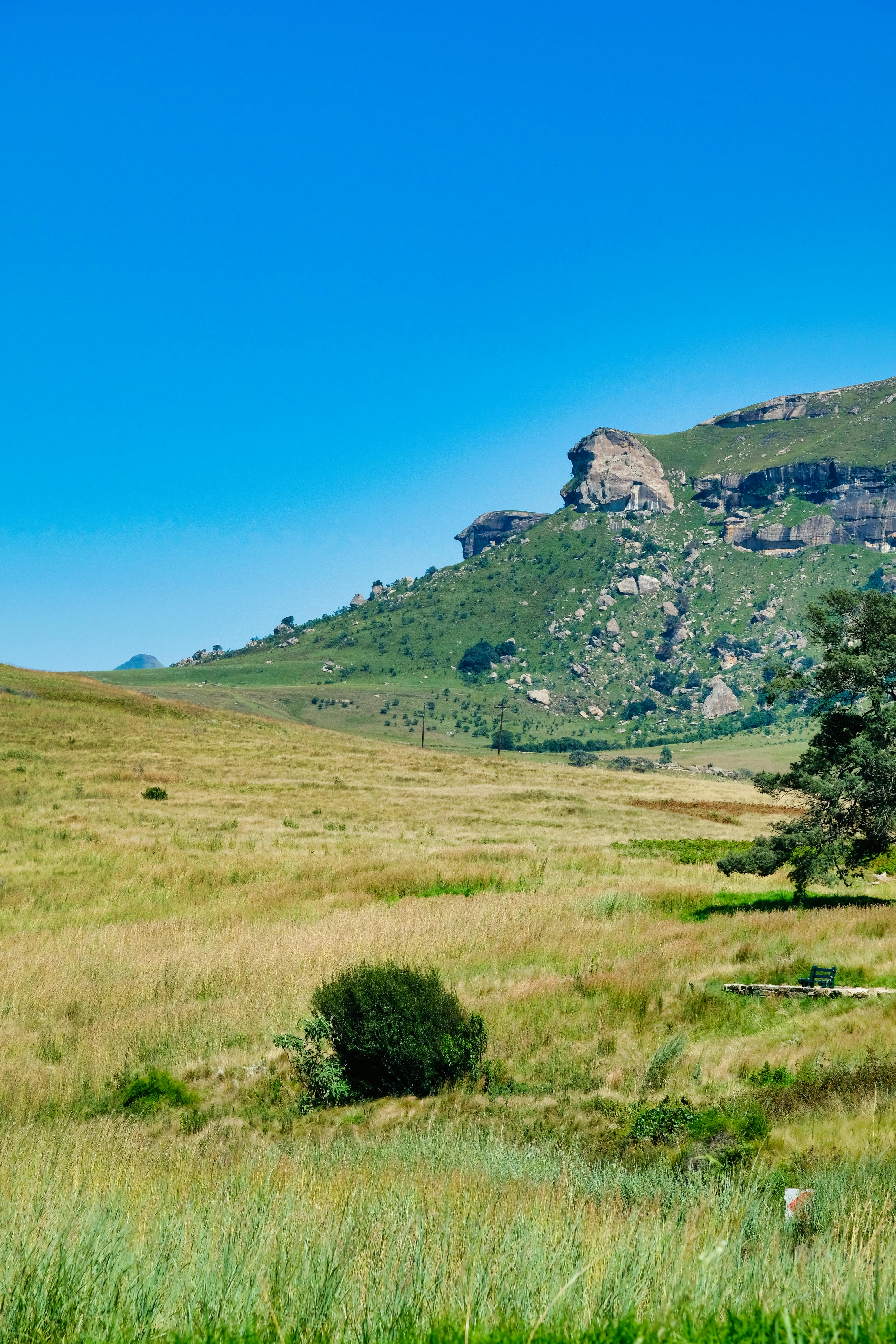 Scenic Landscape with Rocky Outcrop and Grassy Plains · Free Stock Photo