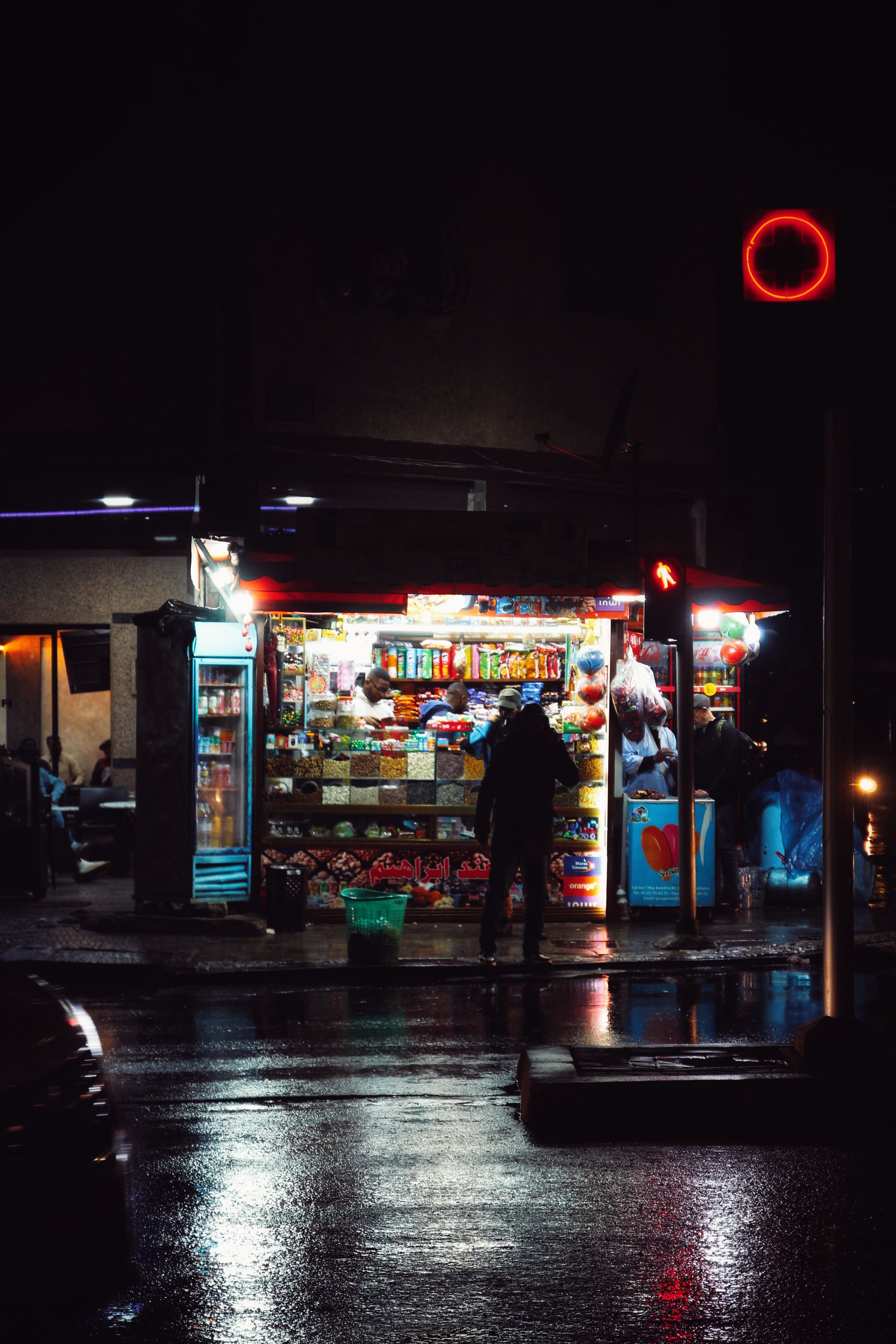 Nighttime Urban Street Vendor Scene with Neon Lights · Free Stock Photo
