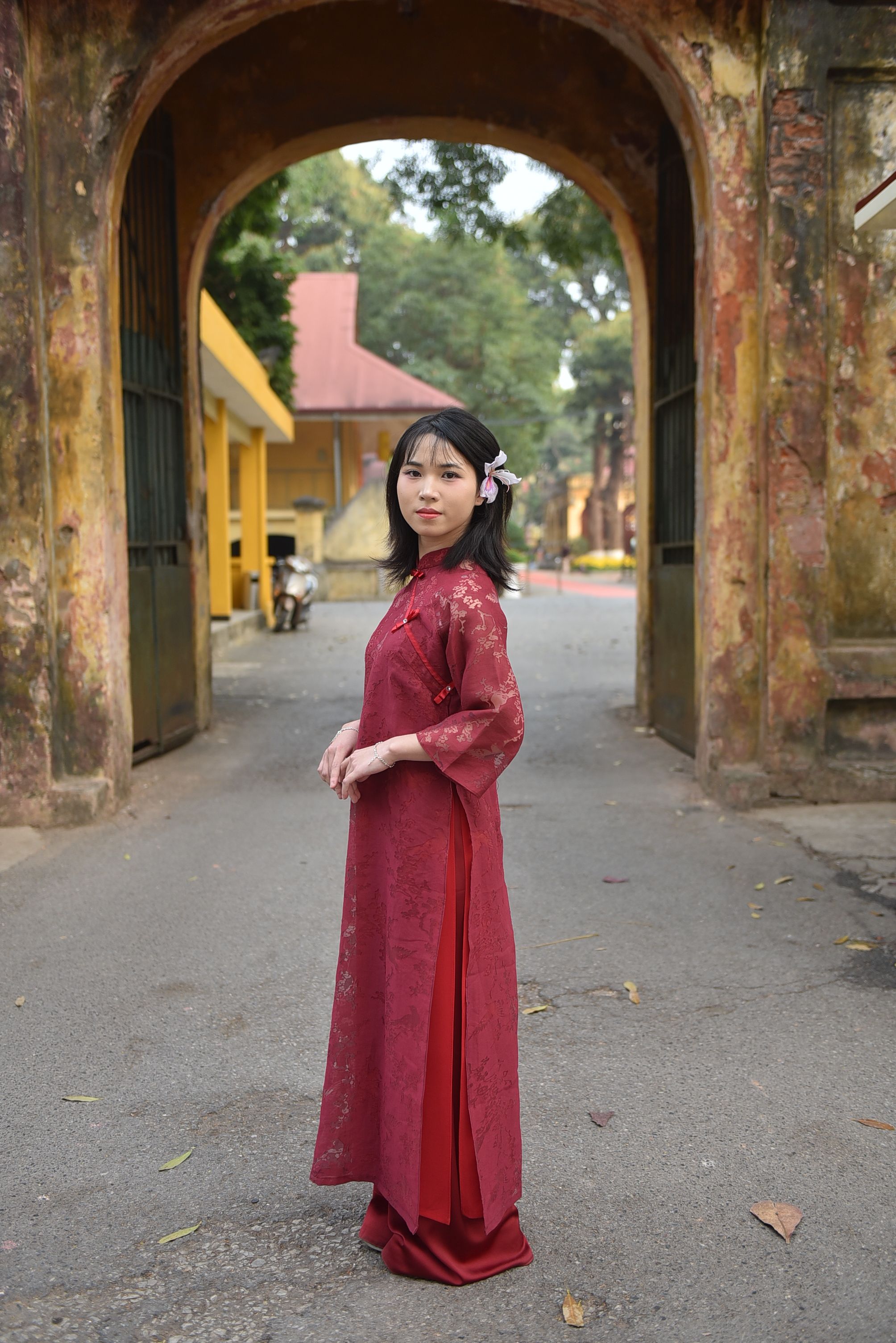 Woman in Traditional Red Dress in Historic Archway · Free Stock Photo