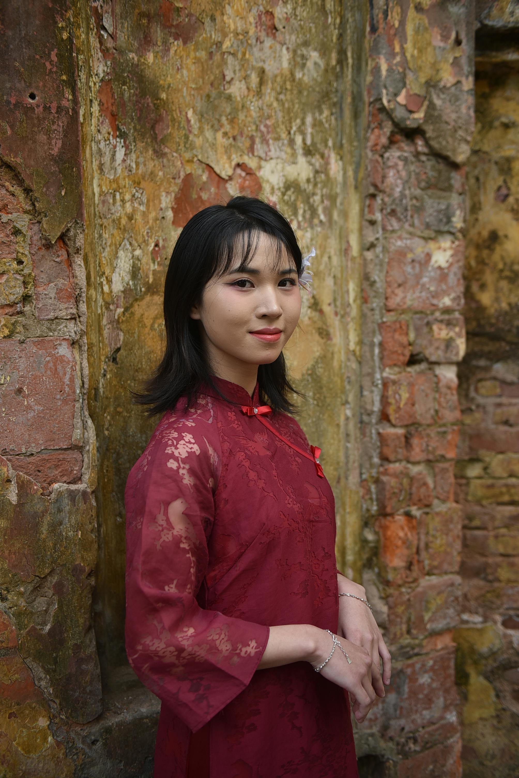 Woman in Traditional Dress by Rustic Wall · Free Stock Photo