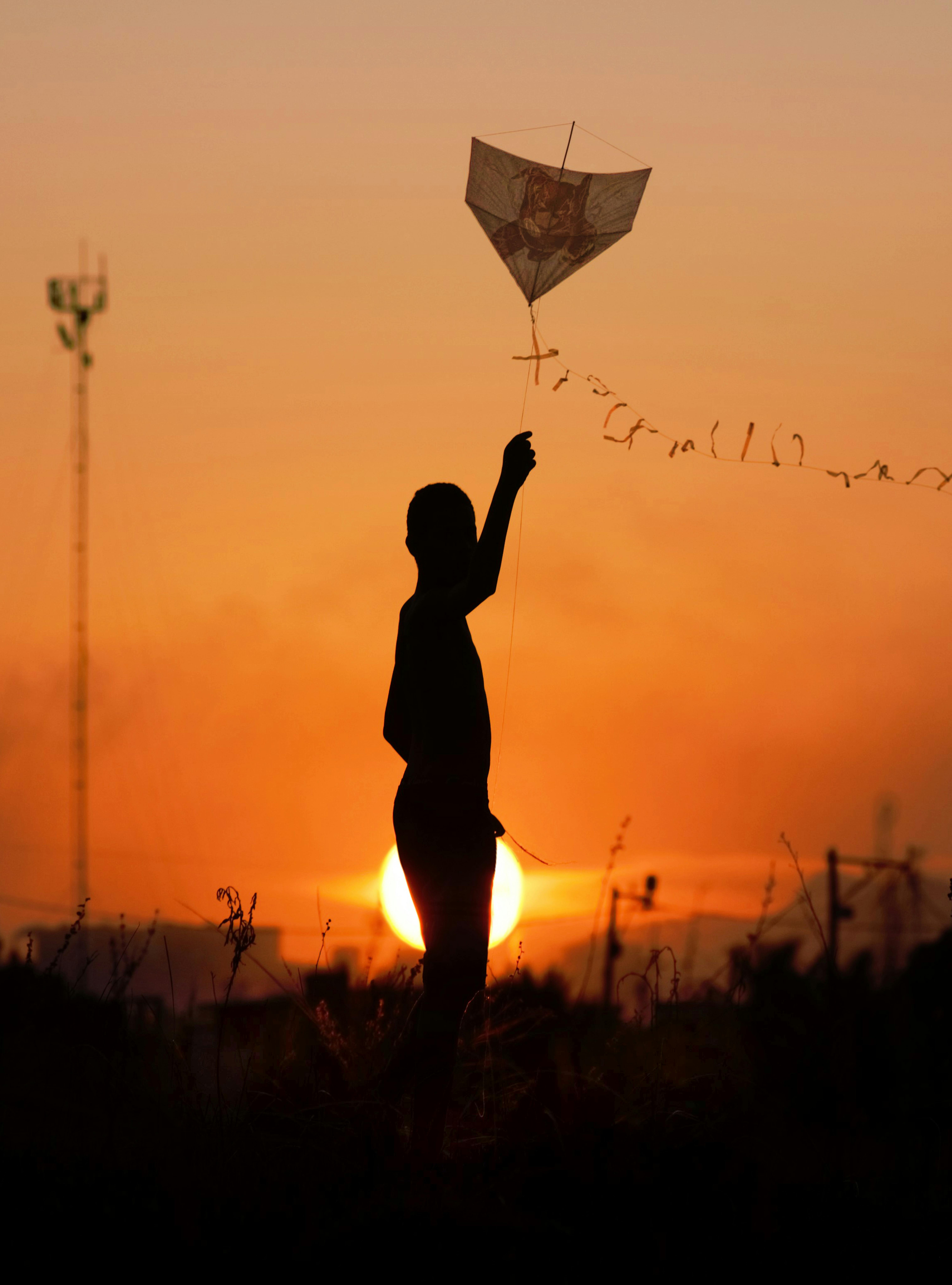 Silhouette of Child Flying Kite at Sunset · Free Stock Photo