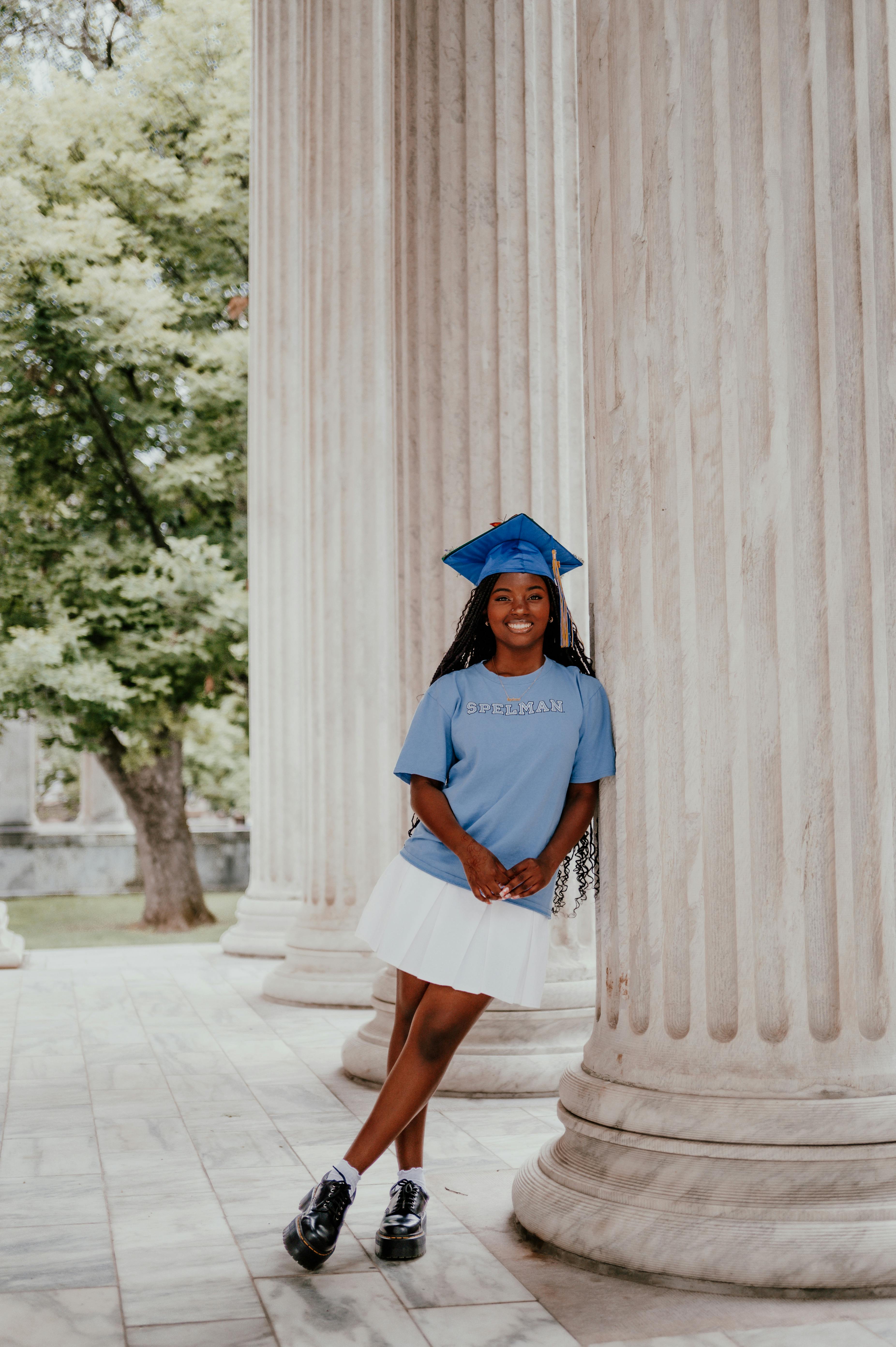Joyful Graduation Portrait at Historic Columns · Free Stock Photo