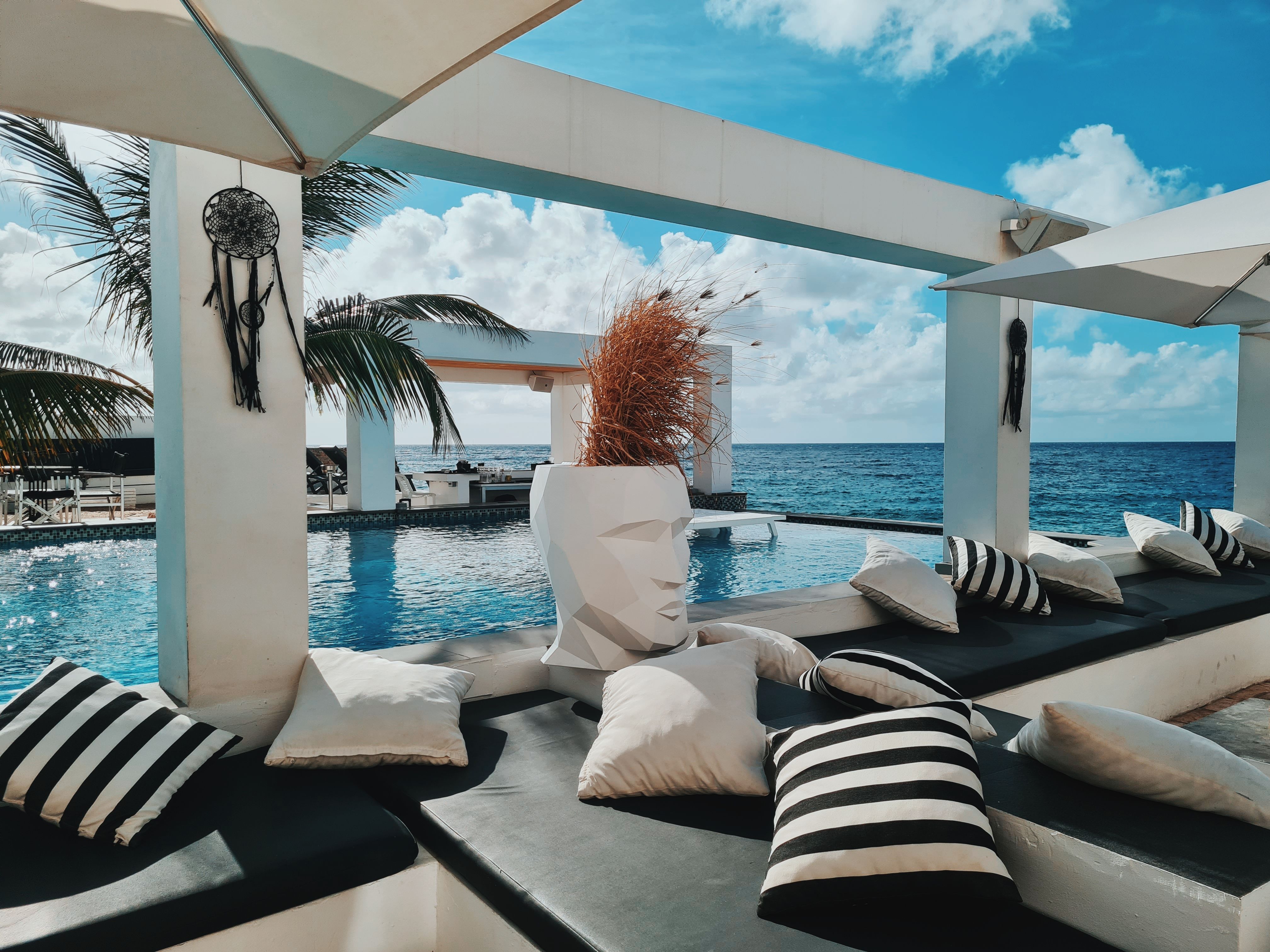 Luxurious Poolside Lounge with Ocean View · Free Stock Photo