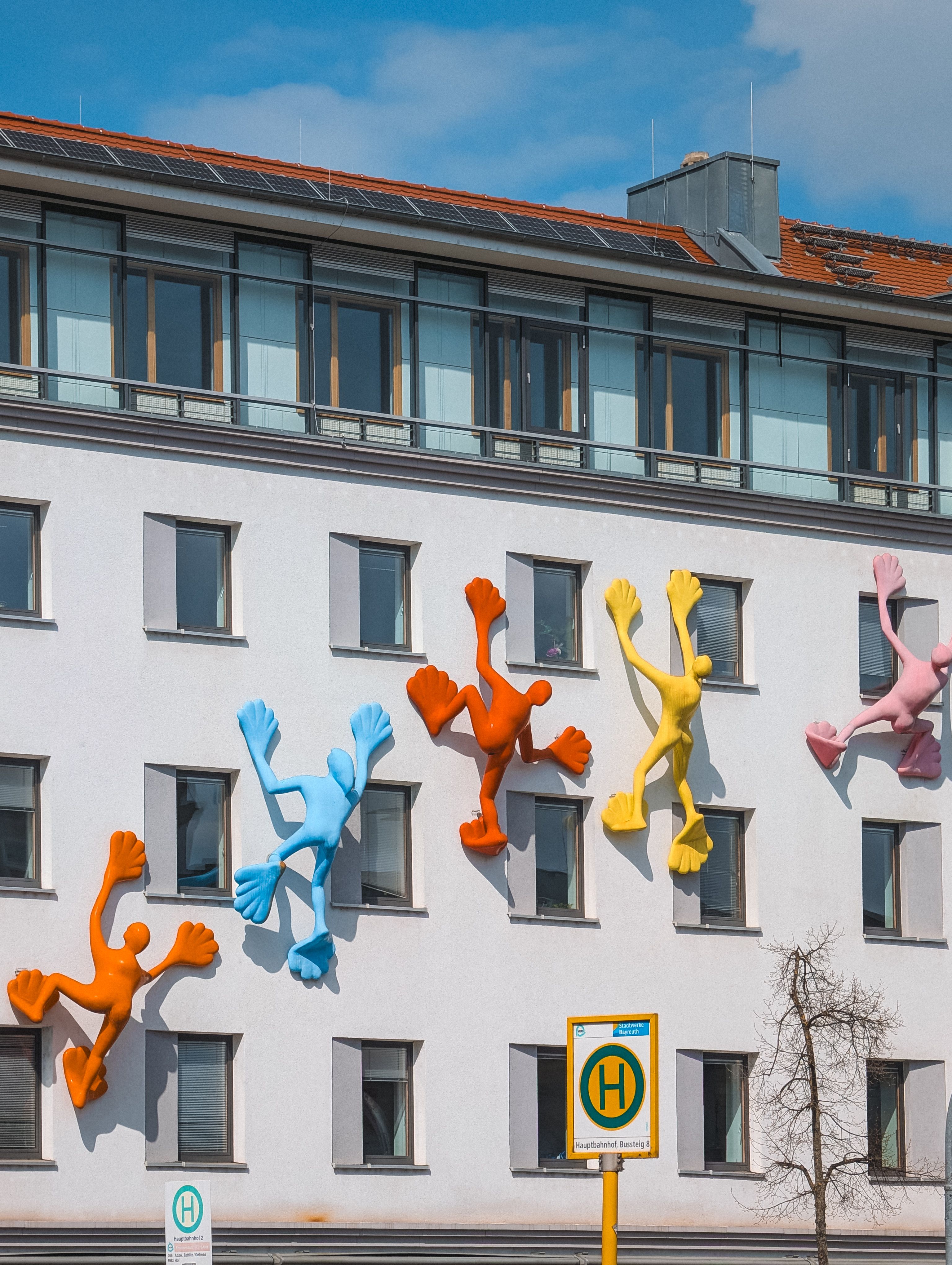 Vibrant Artistic Sculptures on Urban Building · Free Stock Photo