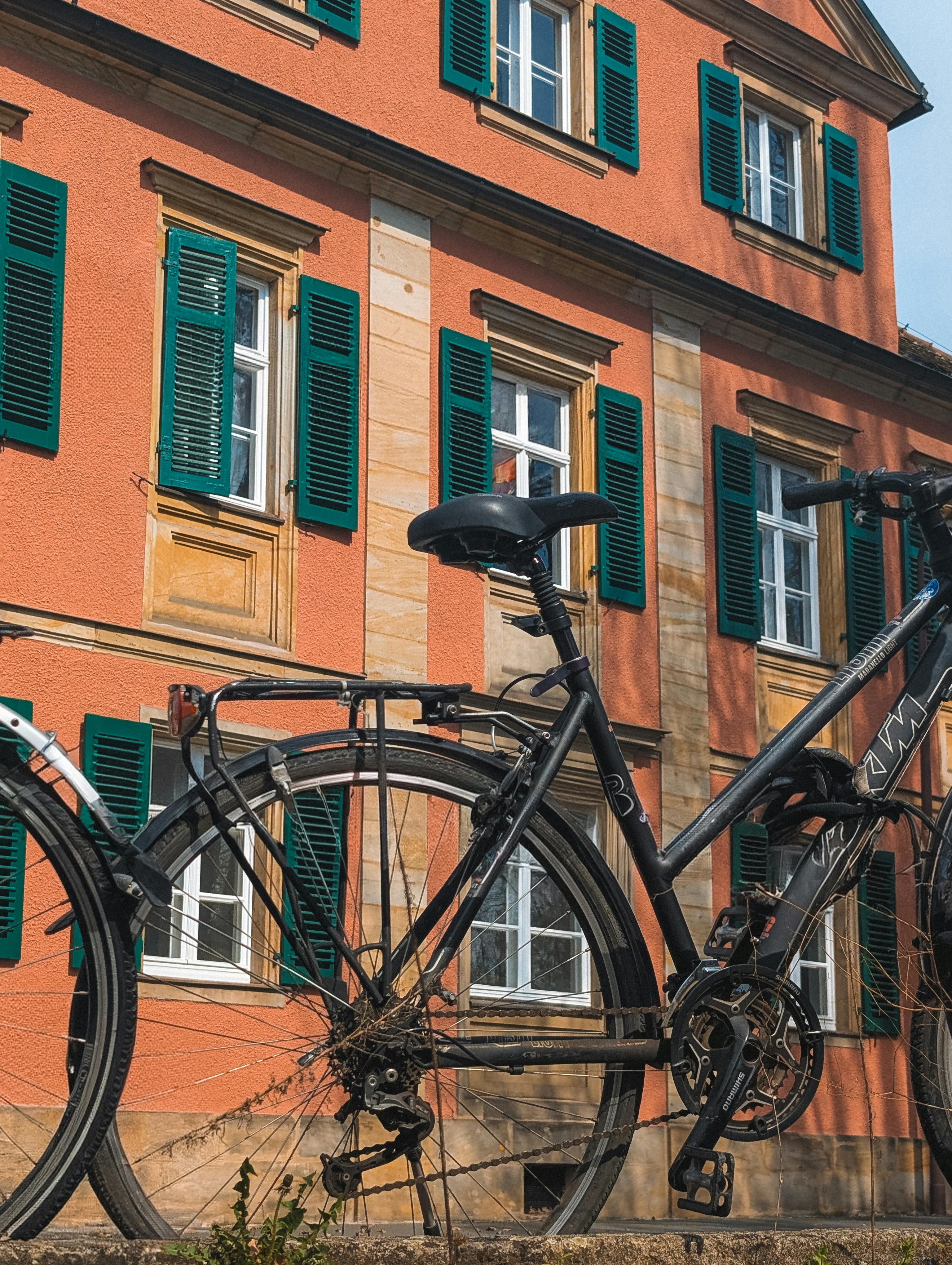 Classic Bicycle Resting Against Historic Building · Free Stock Photo