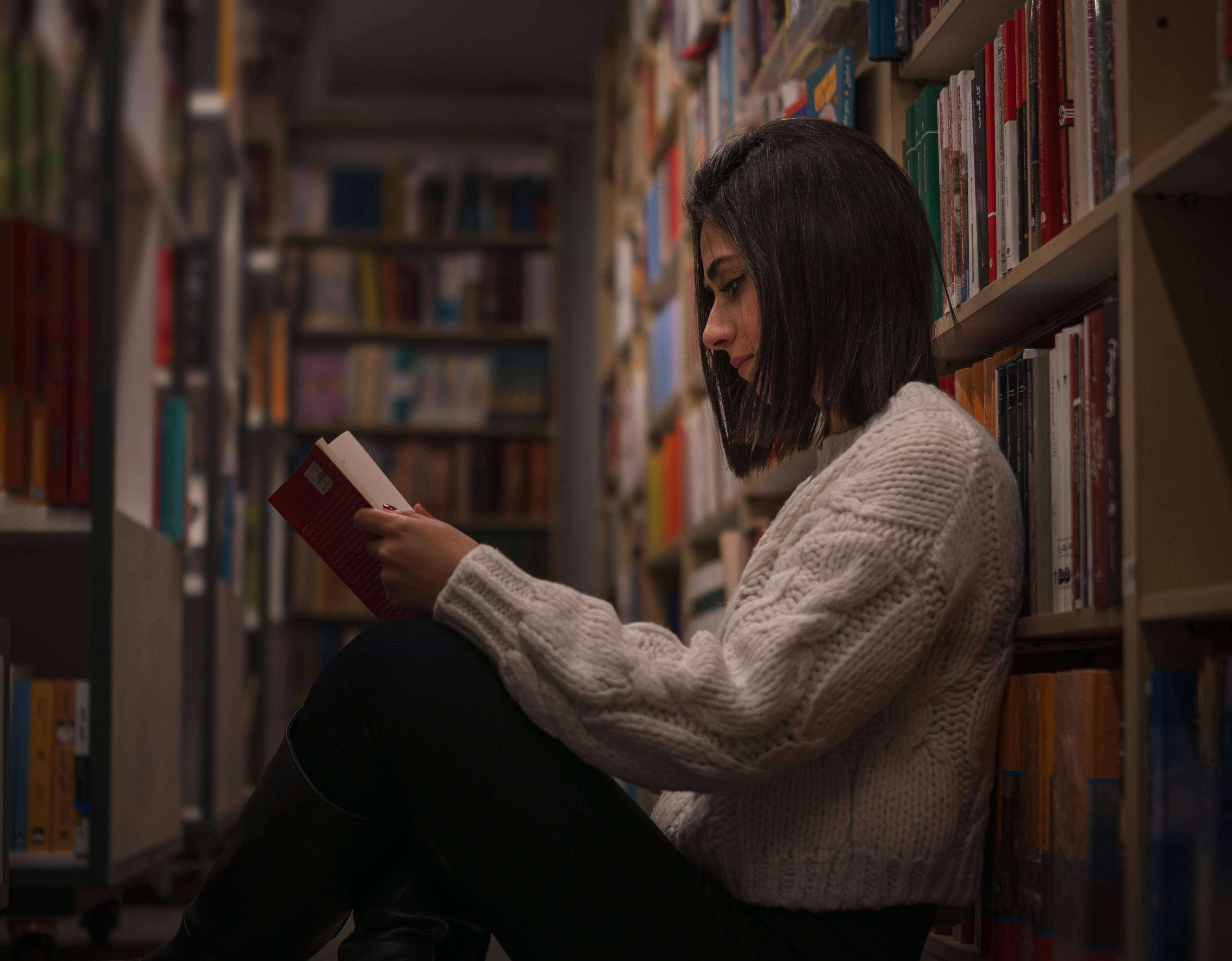 Young Woman Reading in a Cozy Library · Free Stock Photo