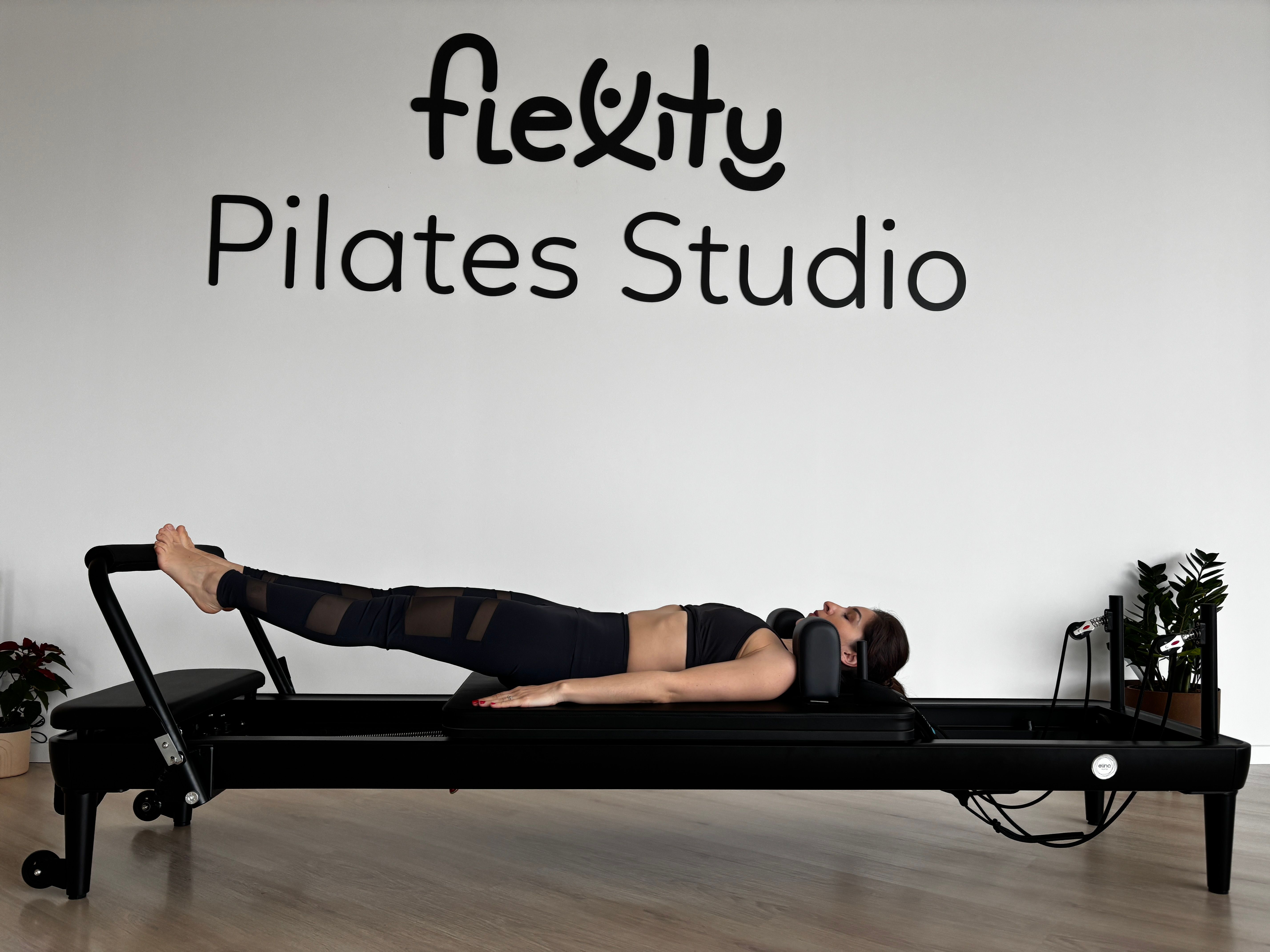 Woman Practicing Pilates on Reformer Machine · Free Stock Photo