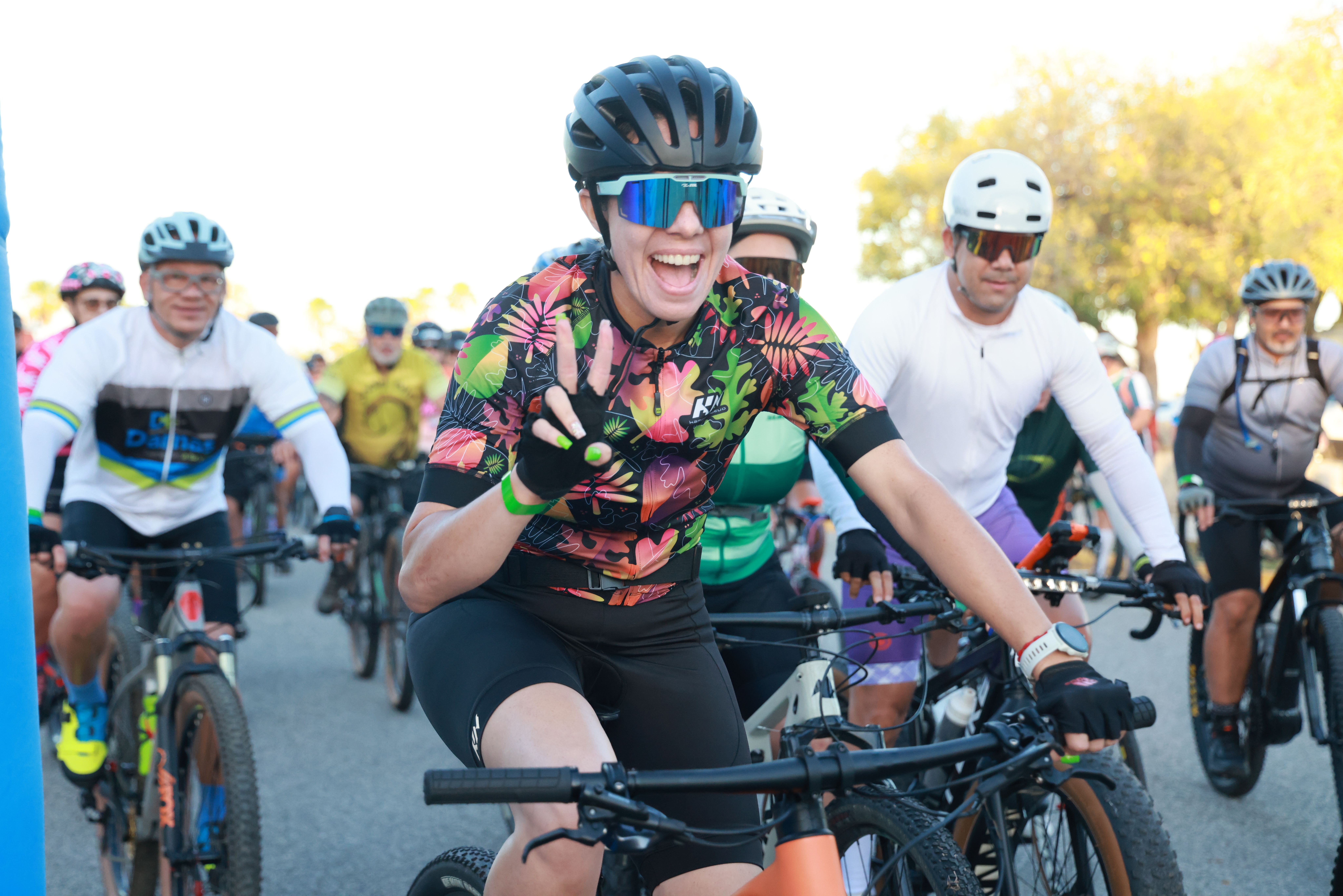 Cyclists in vibrant attire at outdoor cycling event · Free Stock Photo