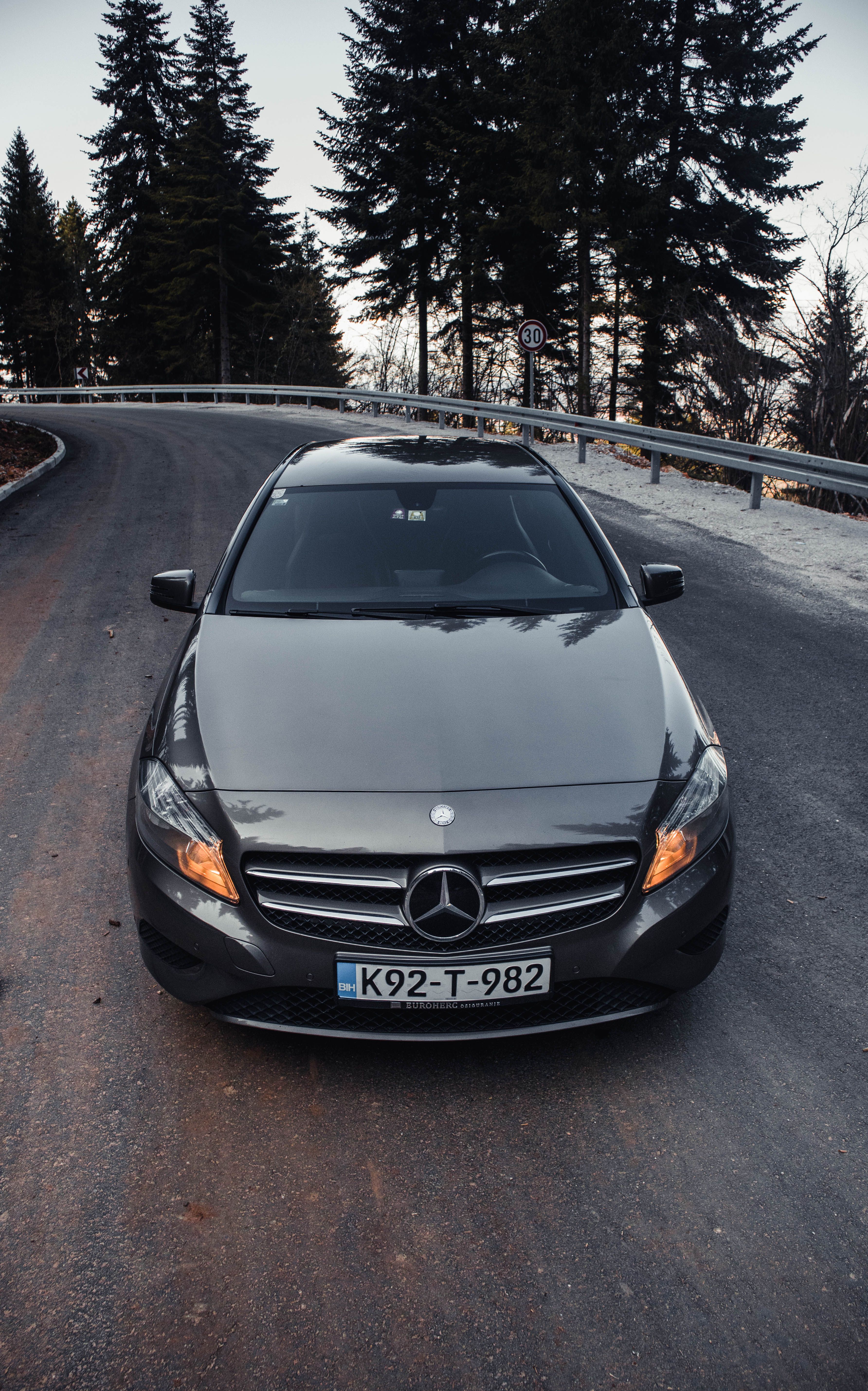 Mercedes-Benz on Curved Road in Forest Setting · Free Stock Photo