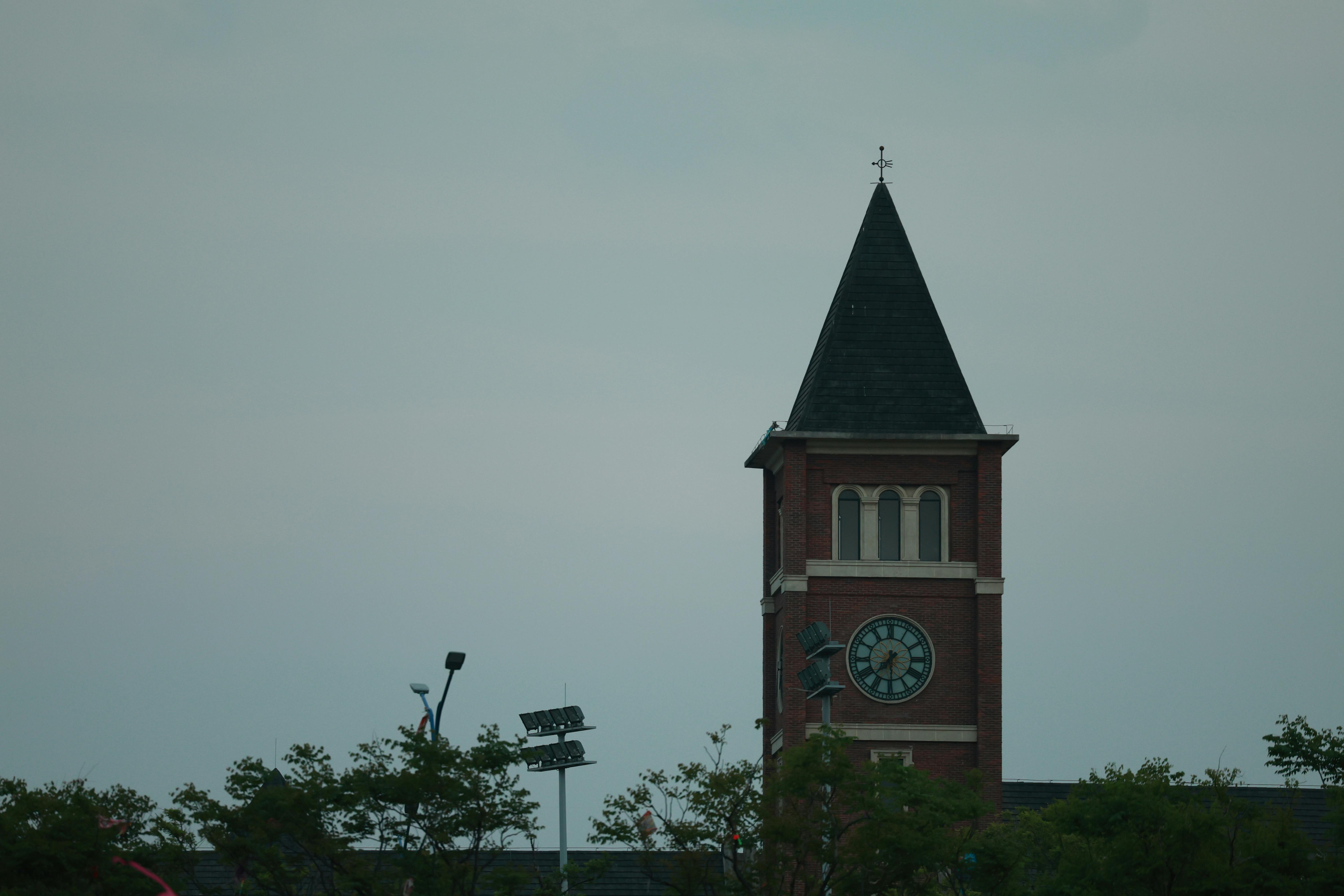 Classic Clock Tower Against Overcast Sky · Free Stock Photo