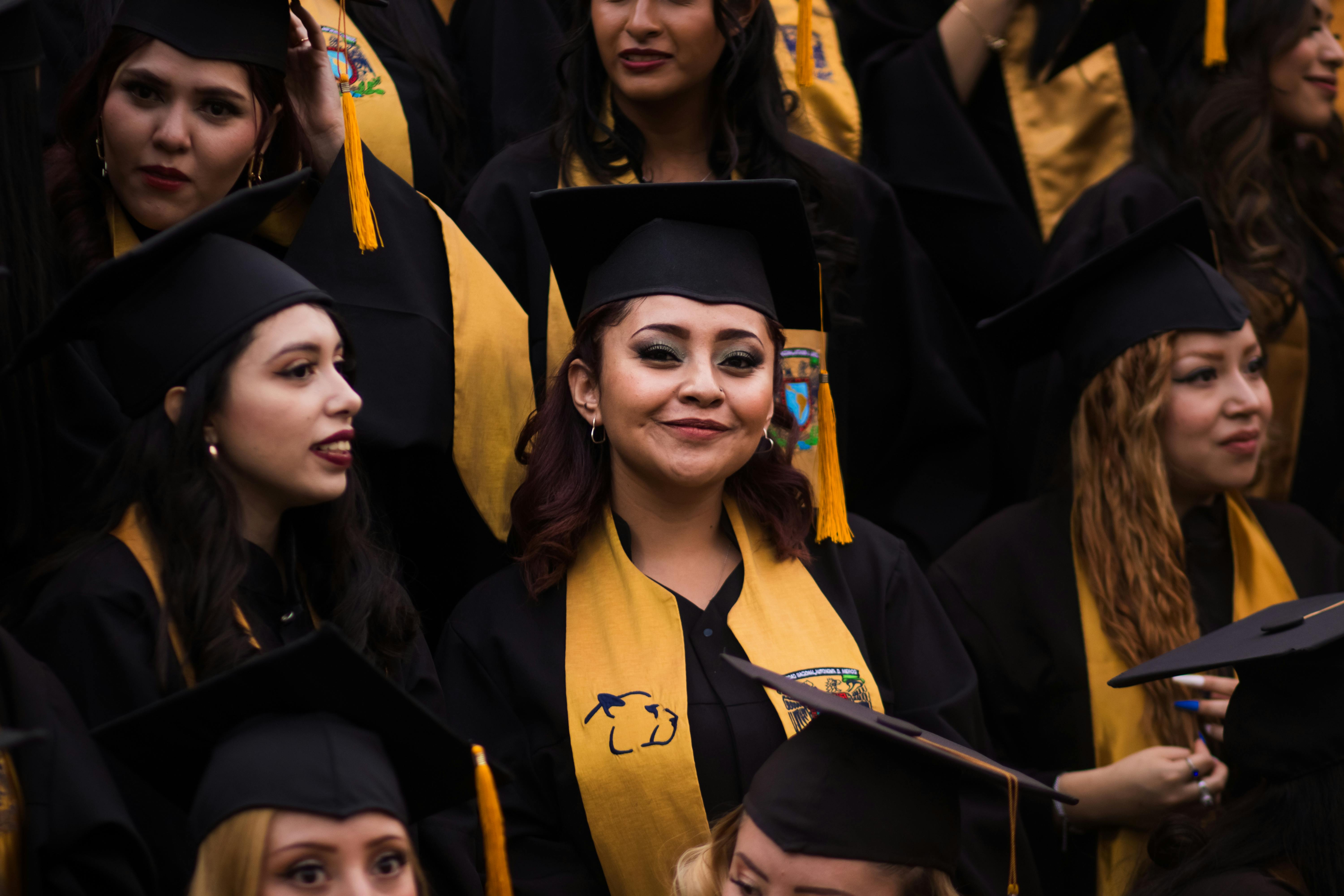 Graduates Celebrating in Ceremony Attire · Free Stock Photo