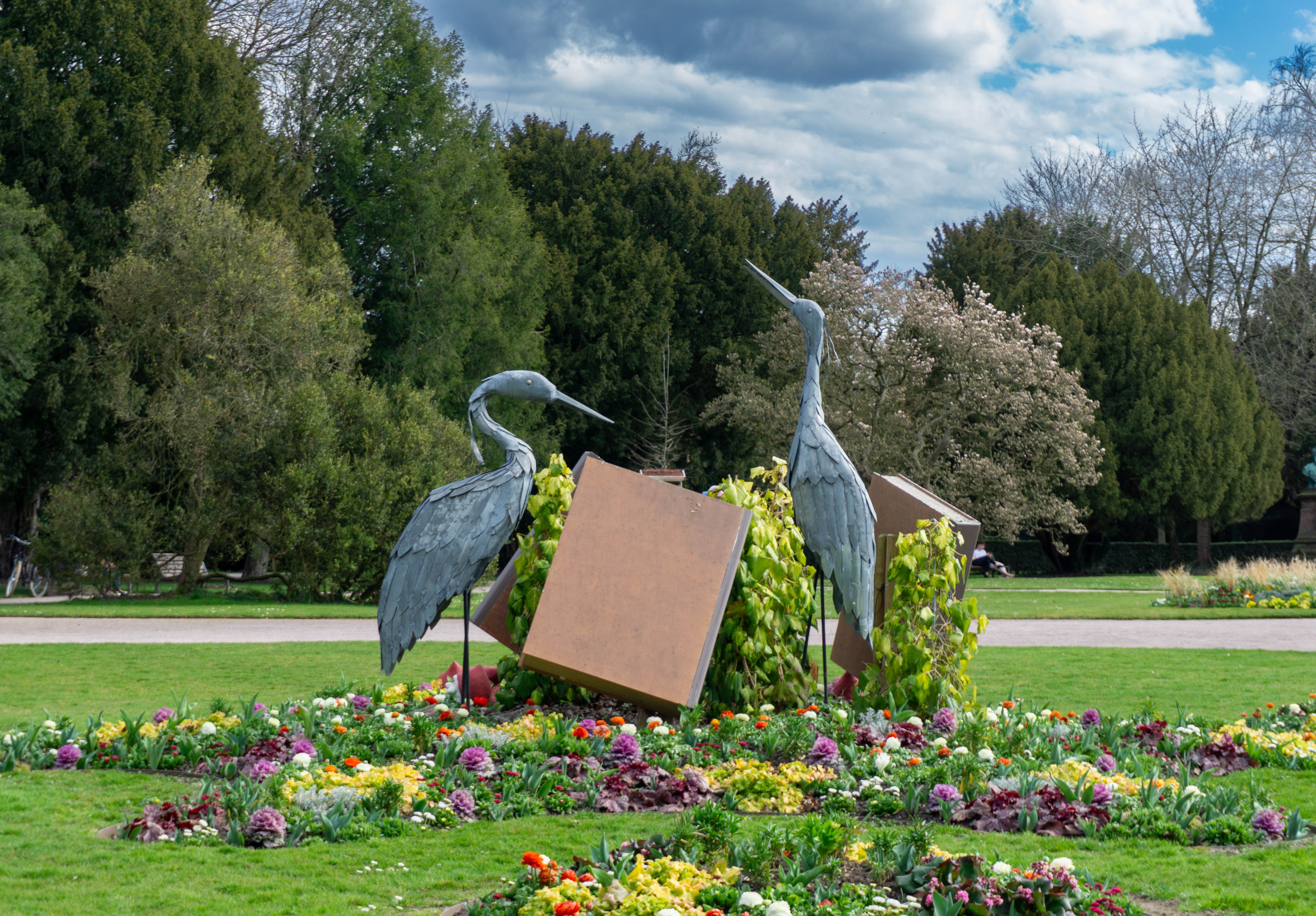 Elegant Stork Sculptures in Strasbourg Park · Free Stock Photo