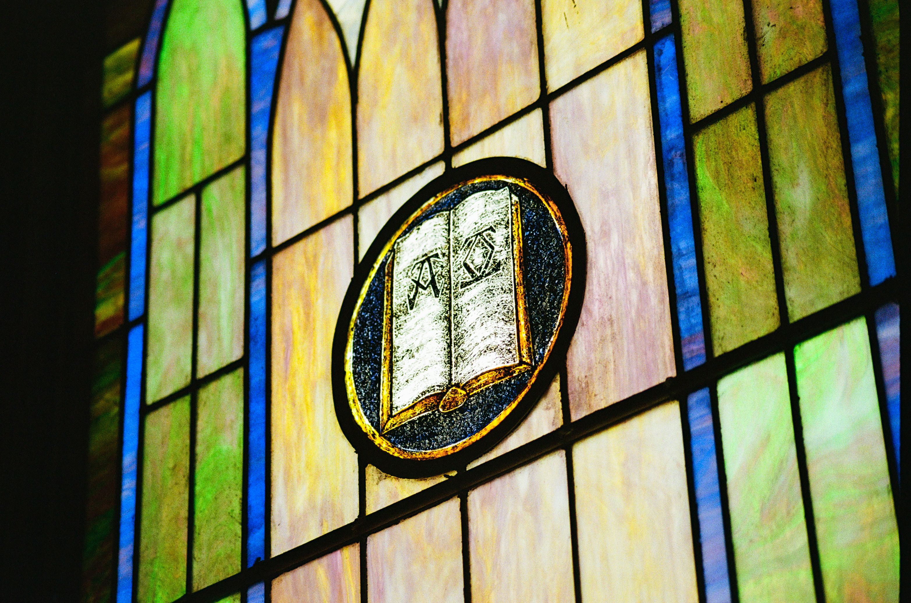 Vibrant Stained Glass Window with Religious Symbol · Free Stock Photo