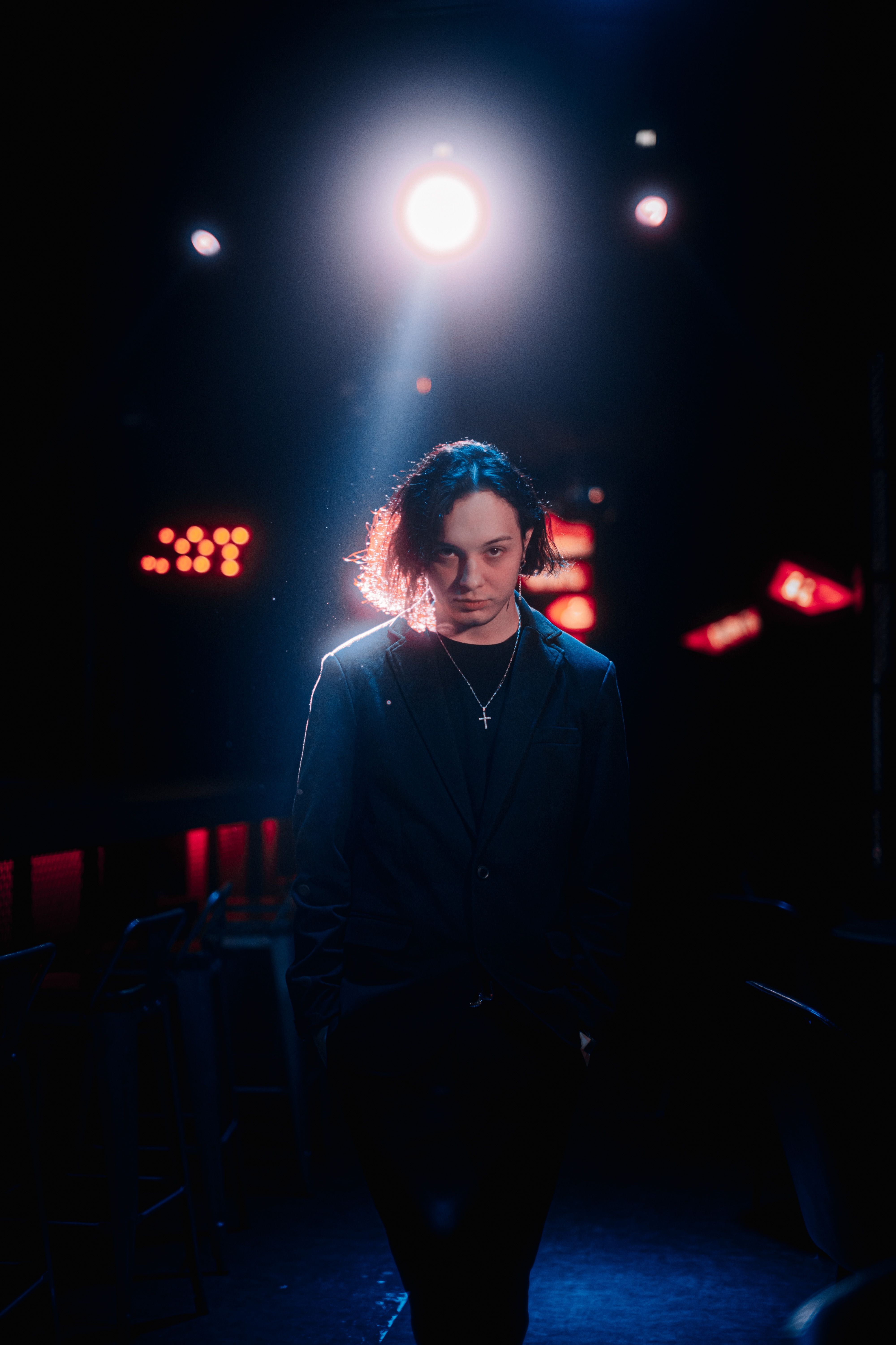 Moody Portrait of a Young Man in Dimly Lit Venue · Free Stock Photo