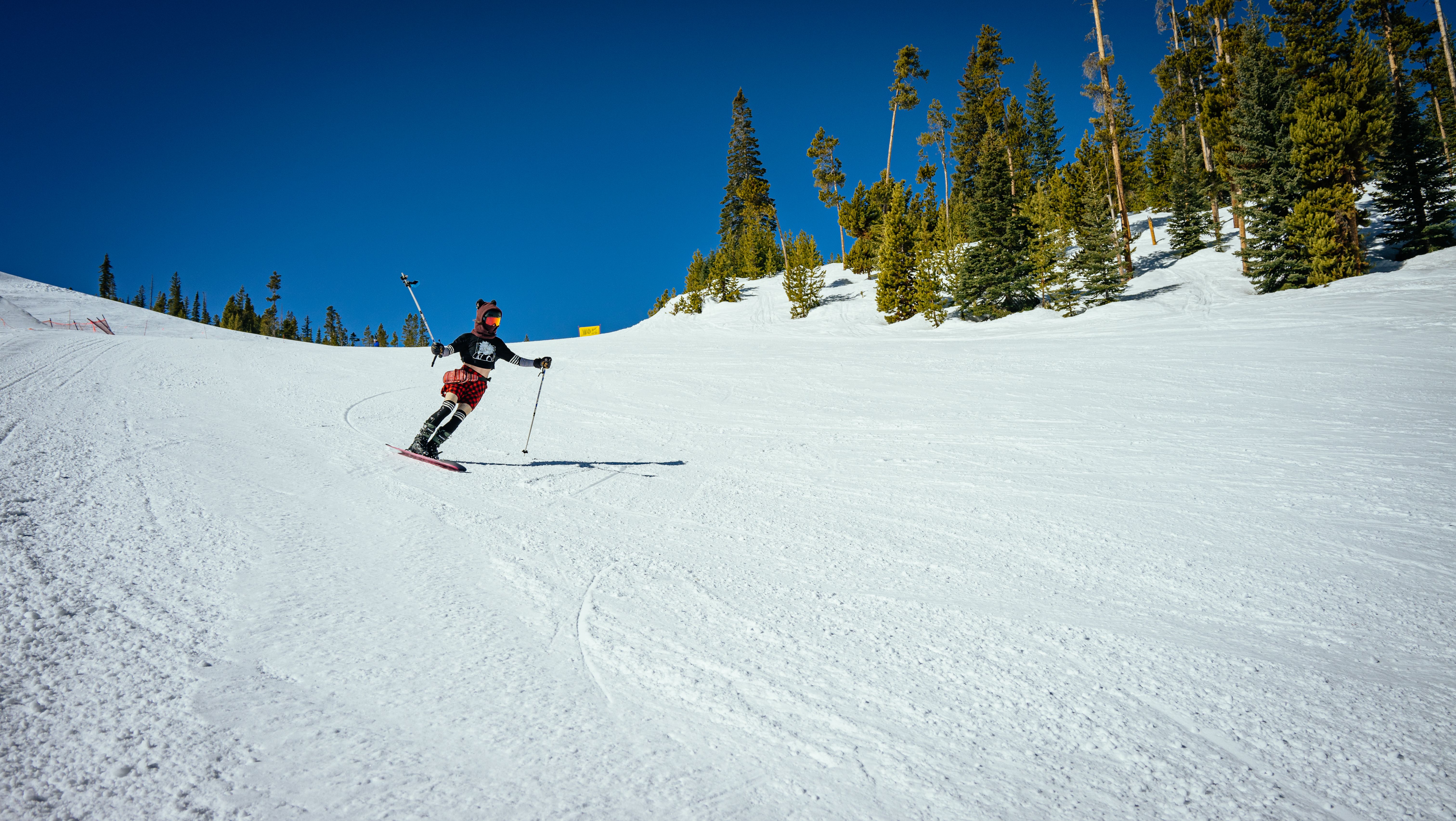 Skier Descending Snowy Slope on Sunny Day · Free Stock Photo