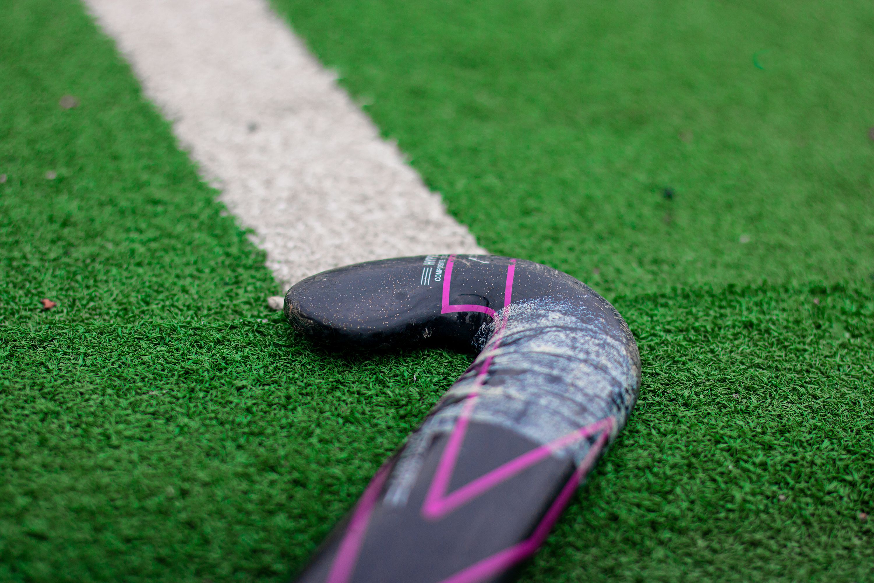 Close-Up of Field Hockey Stick on Turf · Free Stock Photo