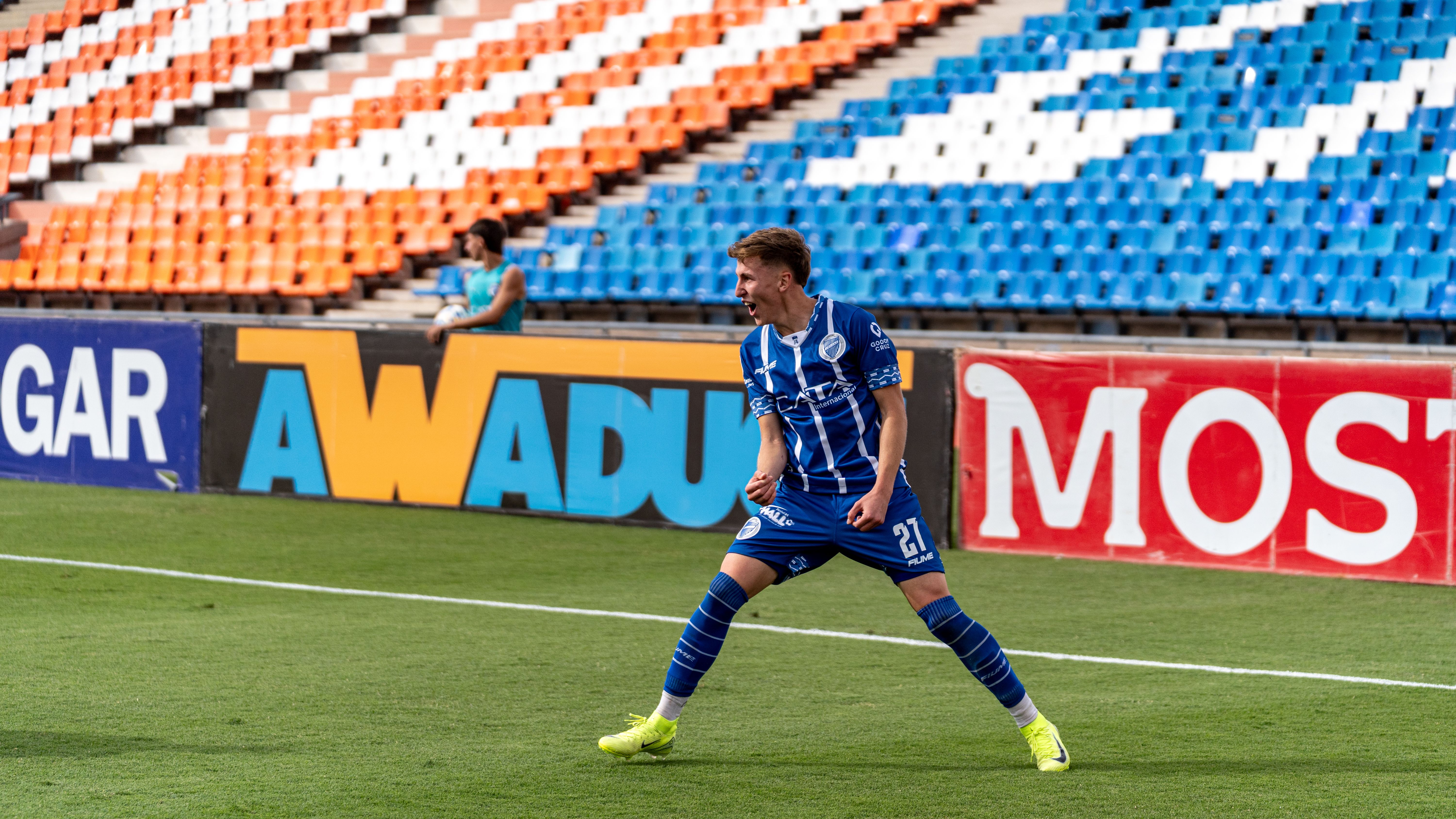 Excited Soccer Player Celebrating Goal on Field · Free Stock Photo