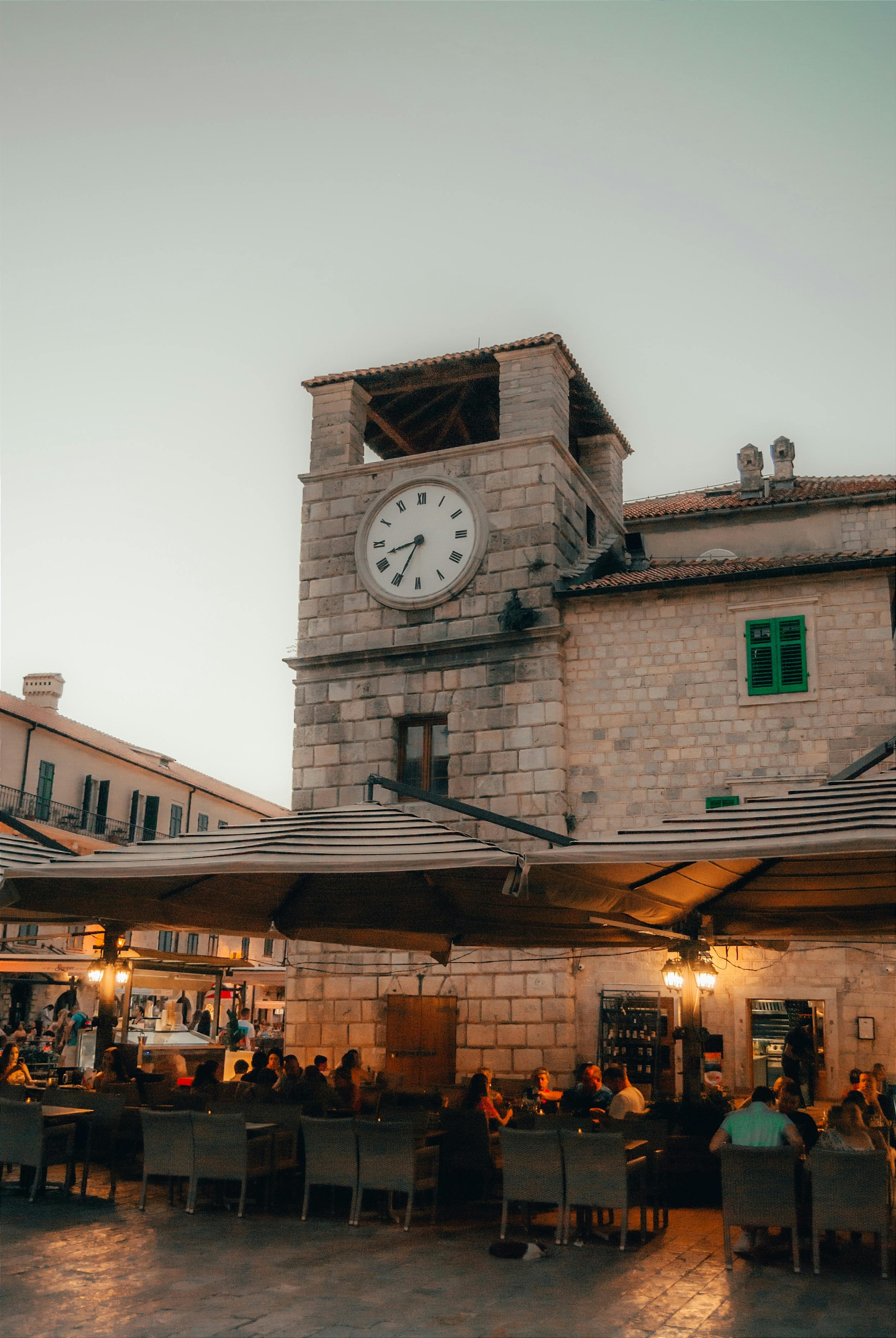 Charming Evening at Historic Clock Tower Plaza · Free Stock Photo