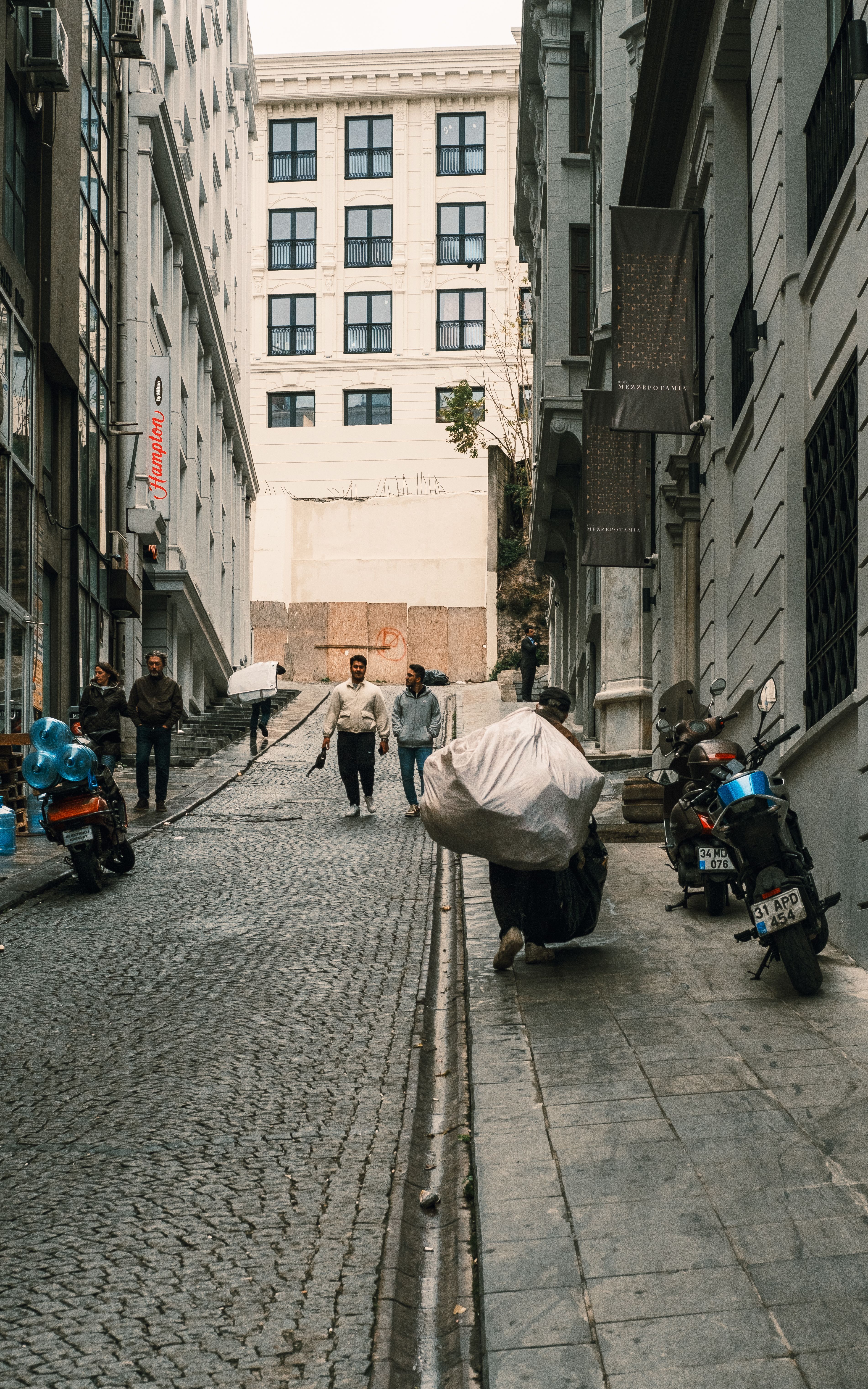 Urban Street Scene with Pedestrians and Motorcycles · Free Stock Photo