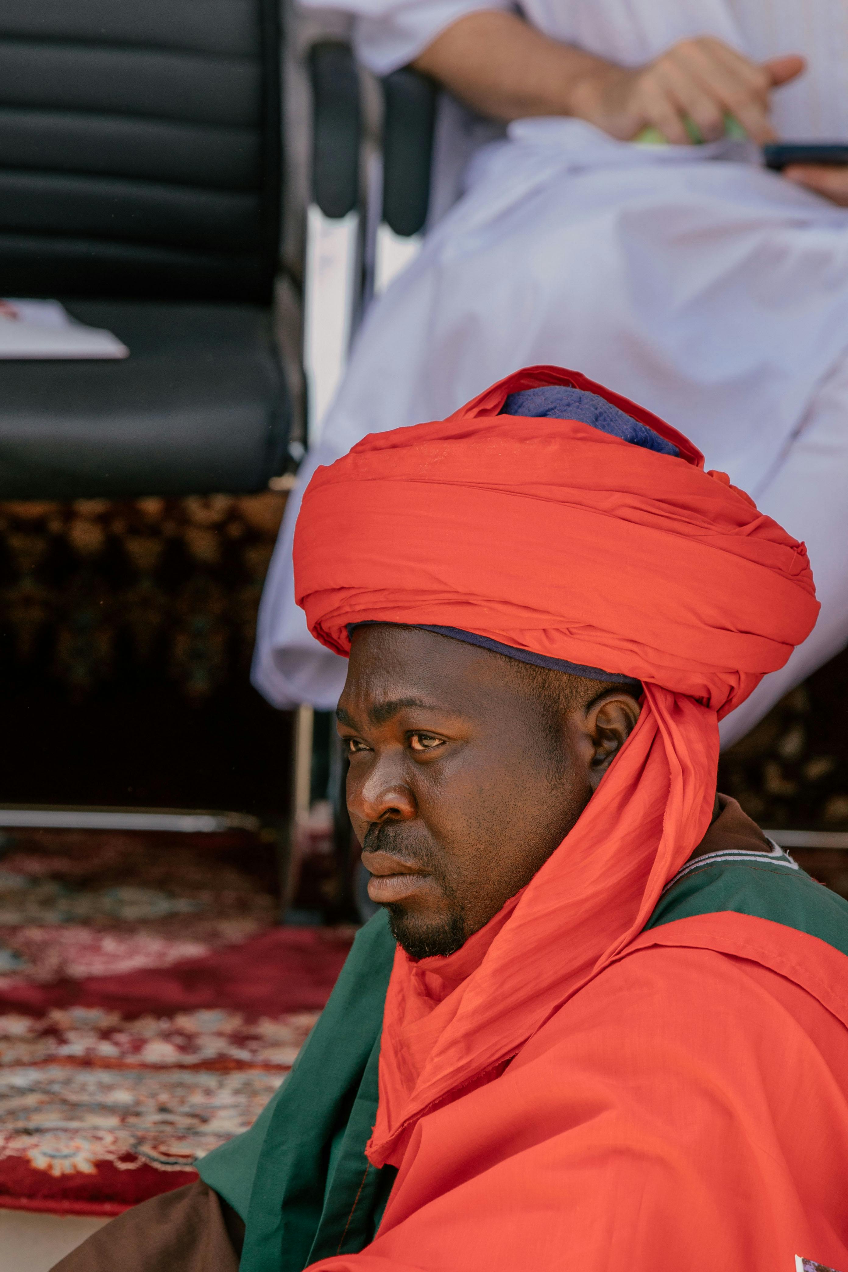 Man in Traditional Red Turban at Cultural Event · Free Stock Photo