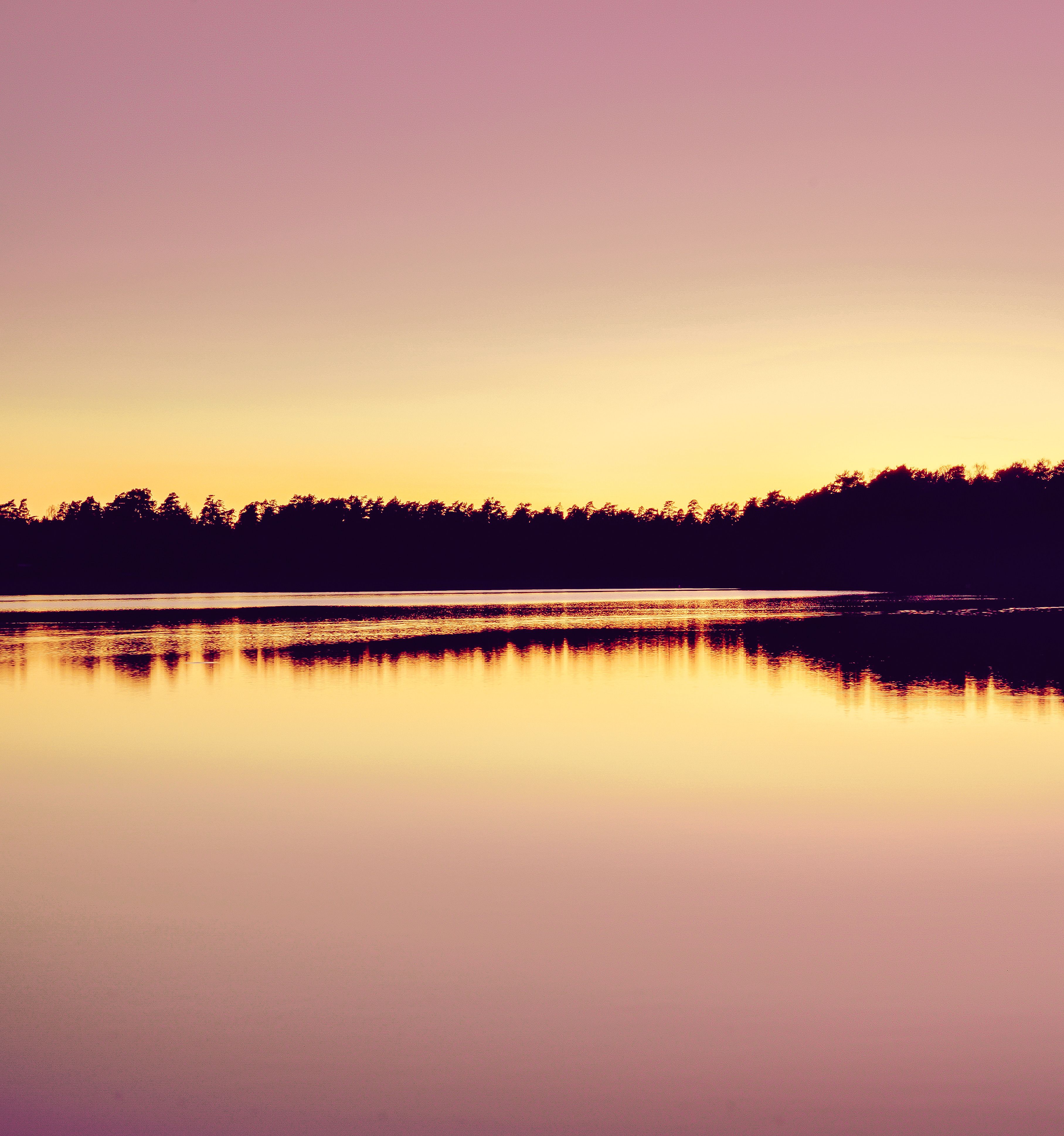 Serene Sunset Over Calm Lake Waters · Free Stock Photo