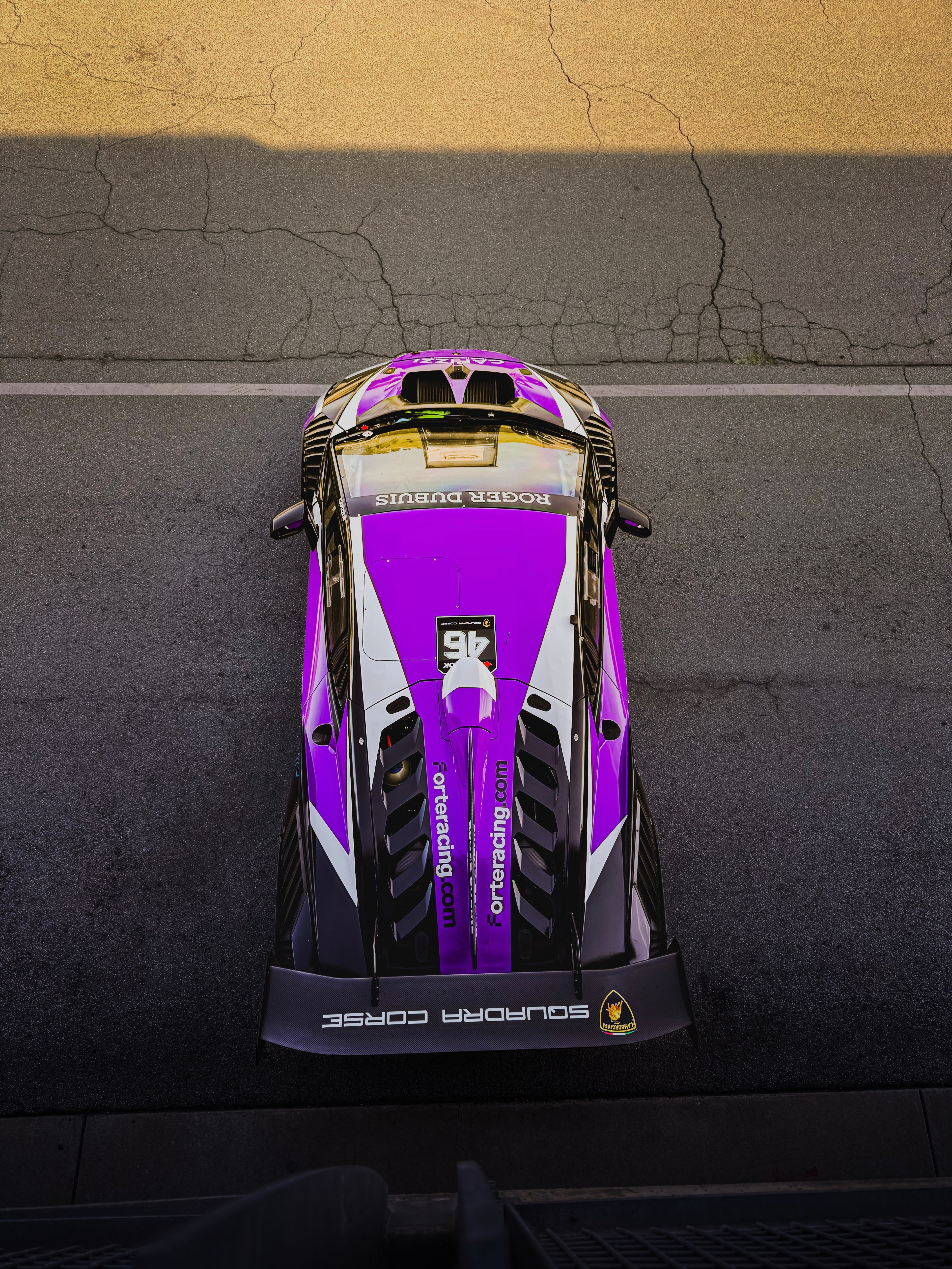 Top View of a Vibrant Racing Car on Track · Free Stock Photo
