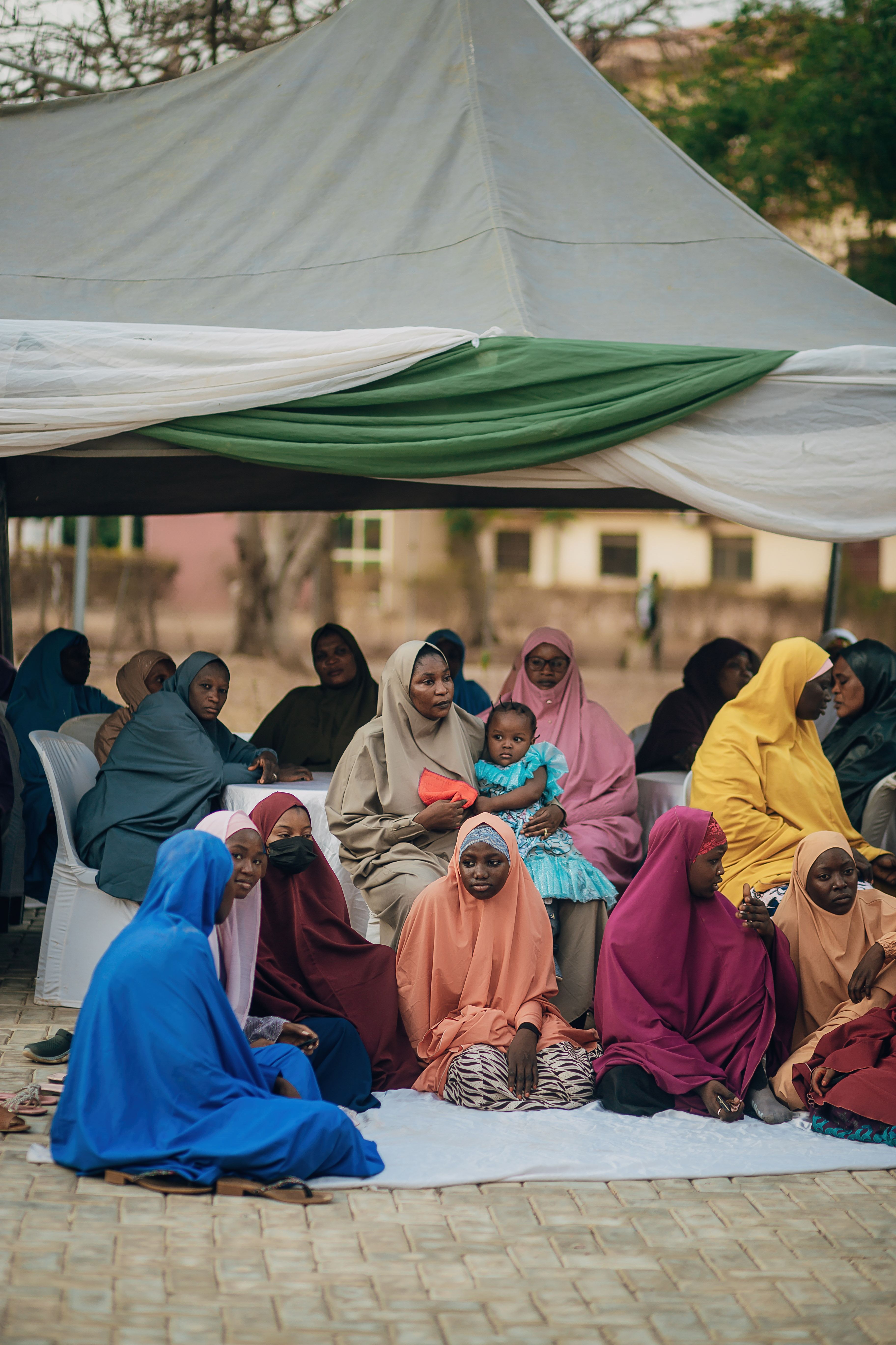 Outdoor Community Gathering Under a Tent · Free Stock Photo