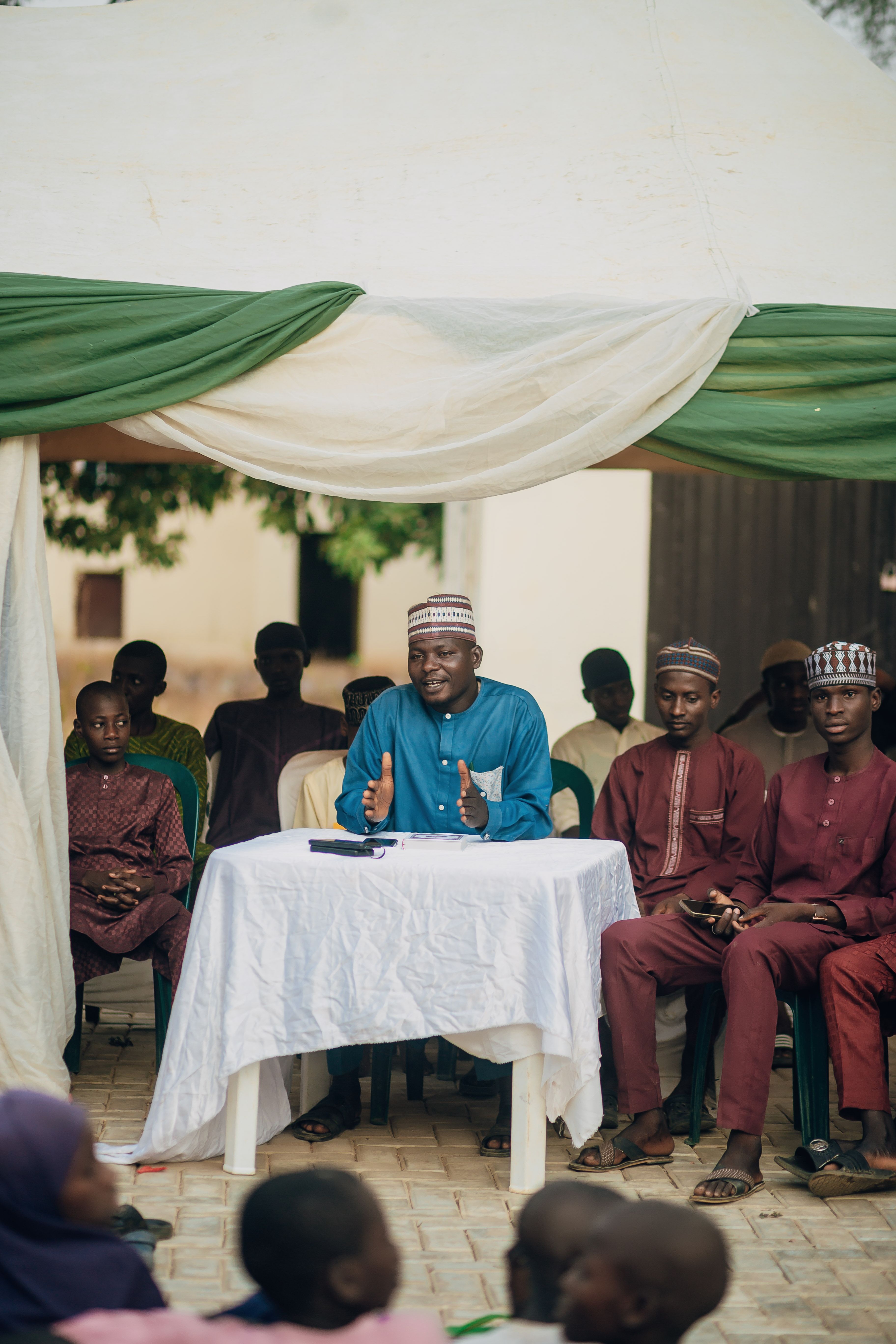 Community Gathering Under Outdoor Tent · Free Stock Photo