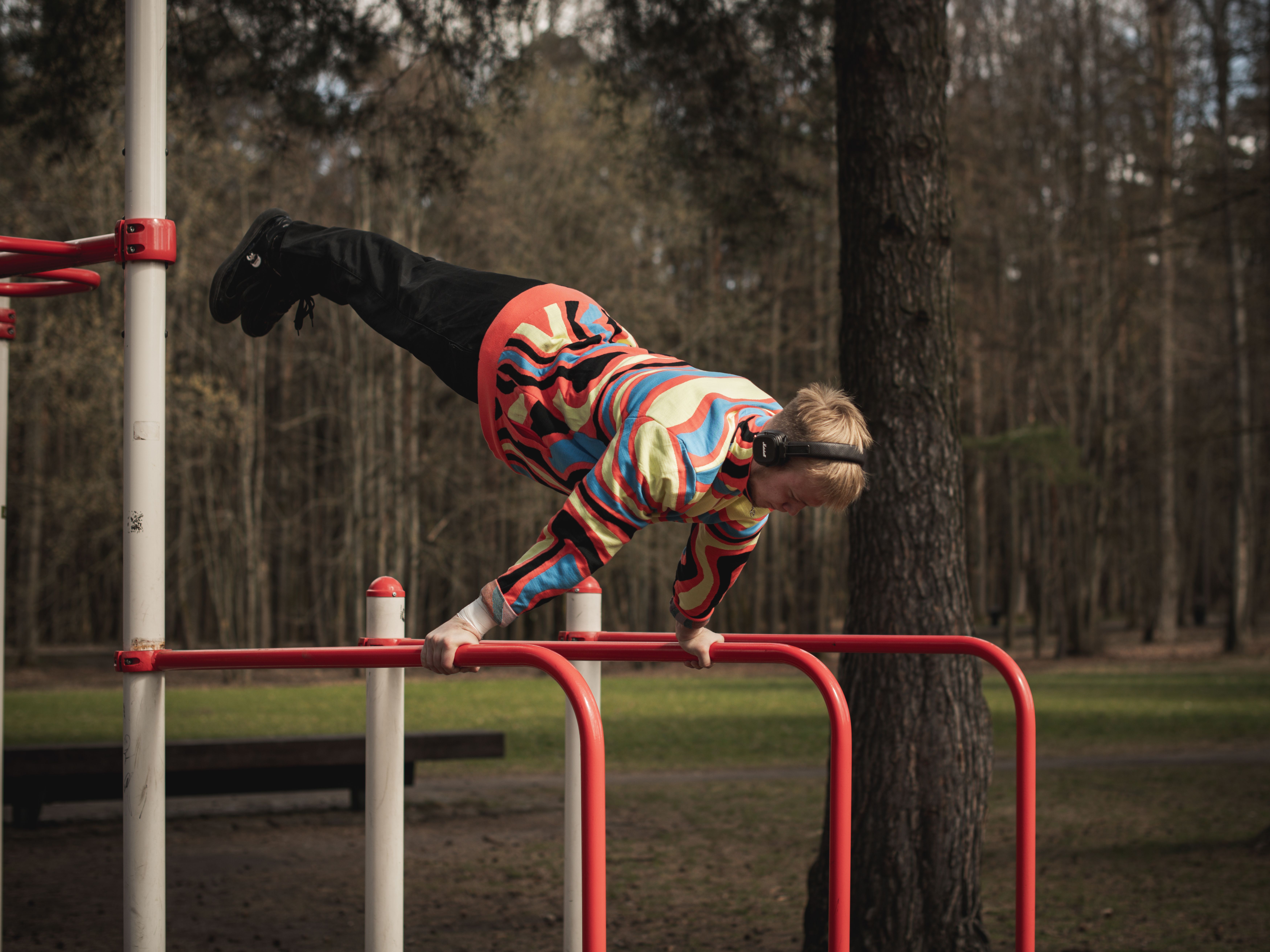 Man Performing Calisthenics on Outdoor Bars in Vilnius · Free Stock Photo