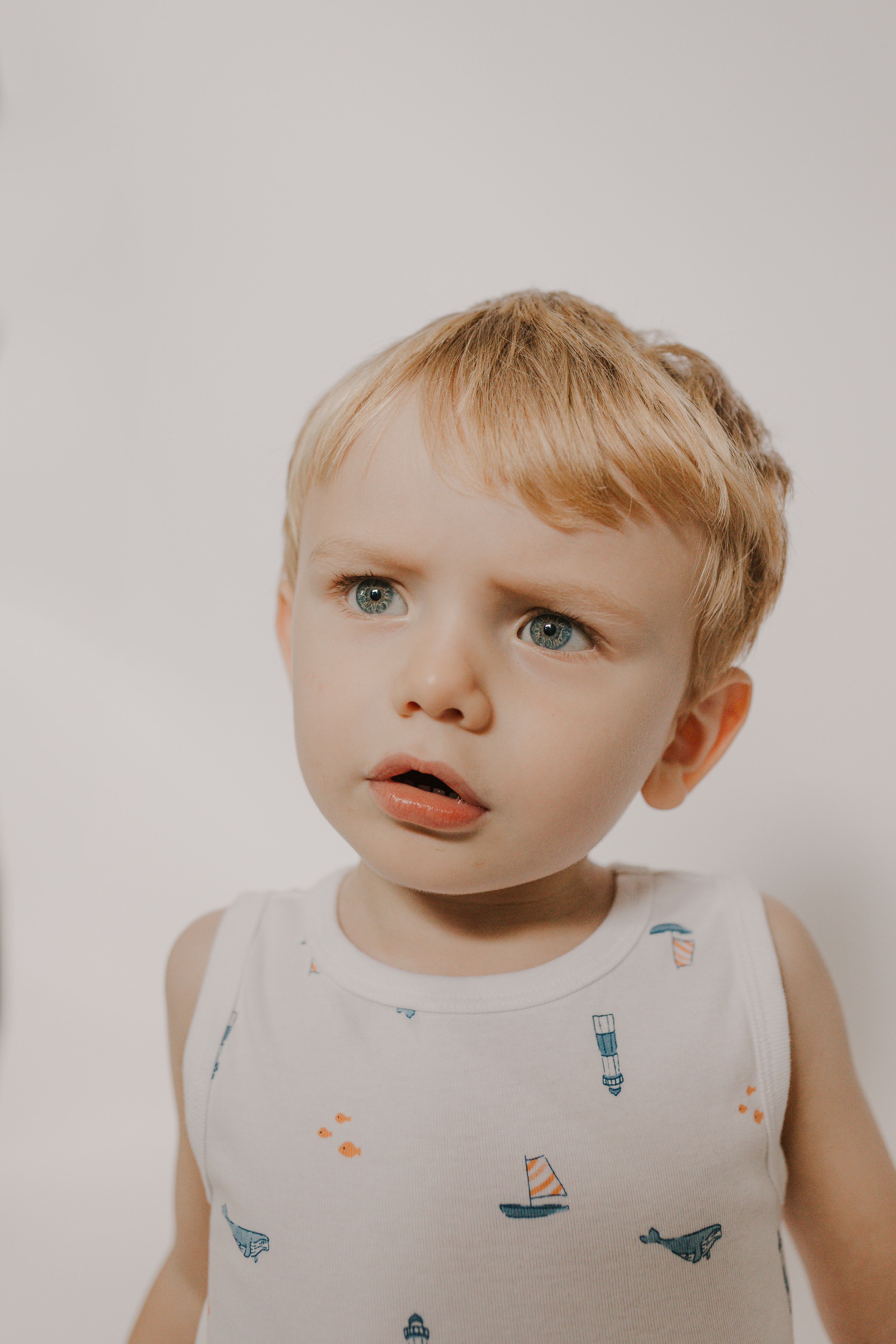 Adorable Toddler with Curious Expression in Studio · Free Stock Photo