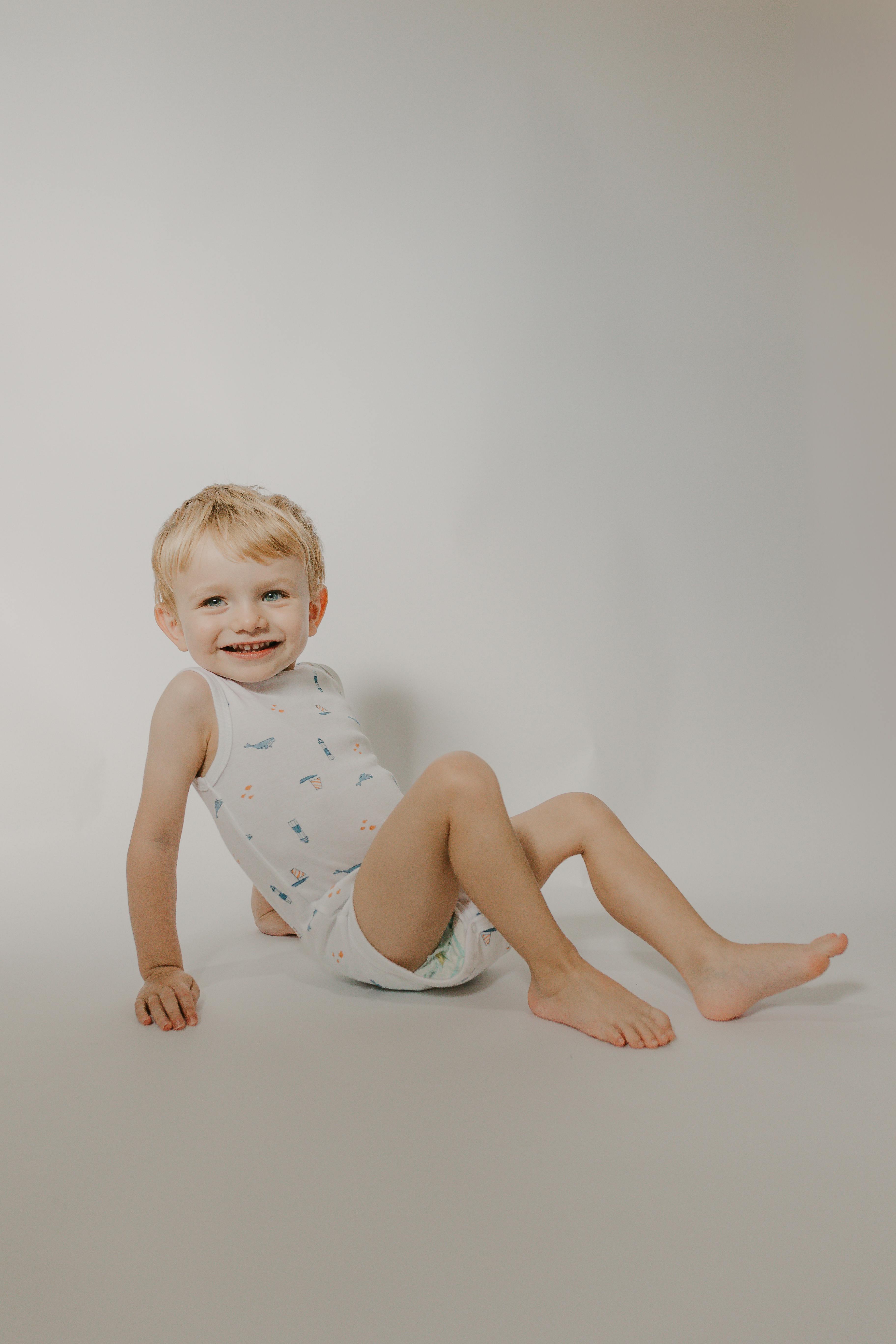 Smiling Toddler in Light Attire in Studio Setting · Free Stock Photo