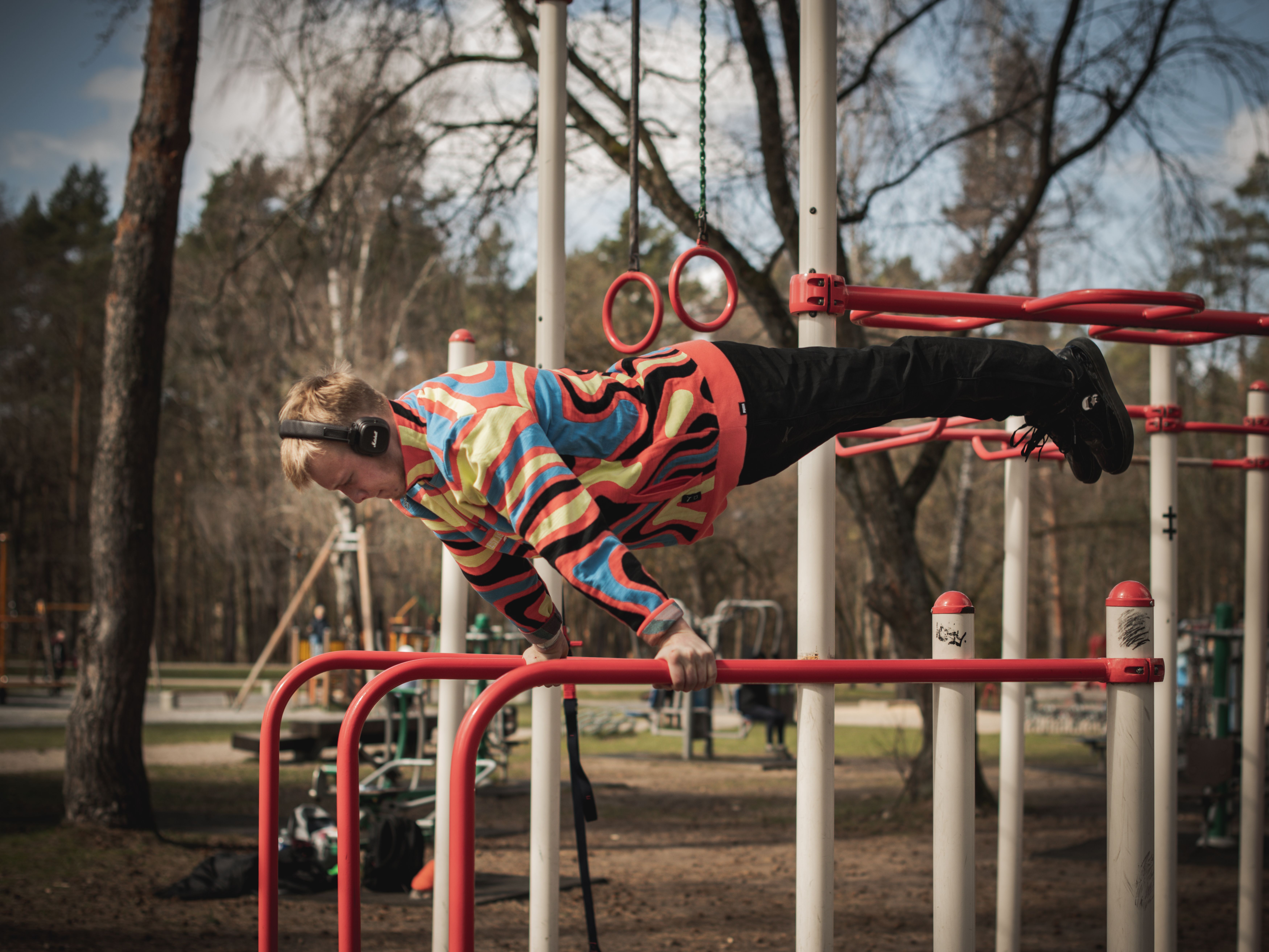 Athletic Man Performing Calisthenics in Outdoor Gym · Free Stock Photo