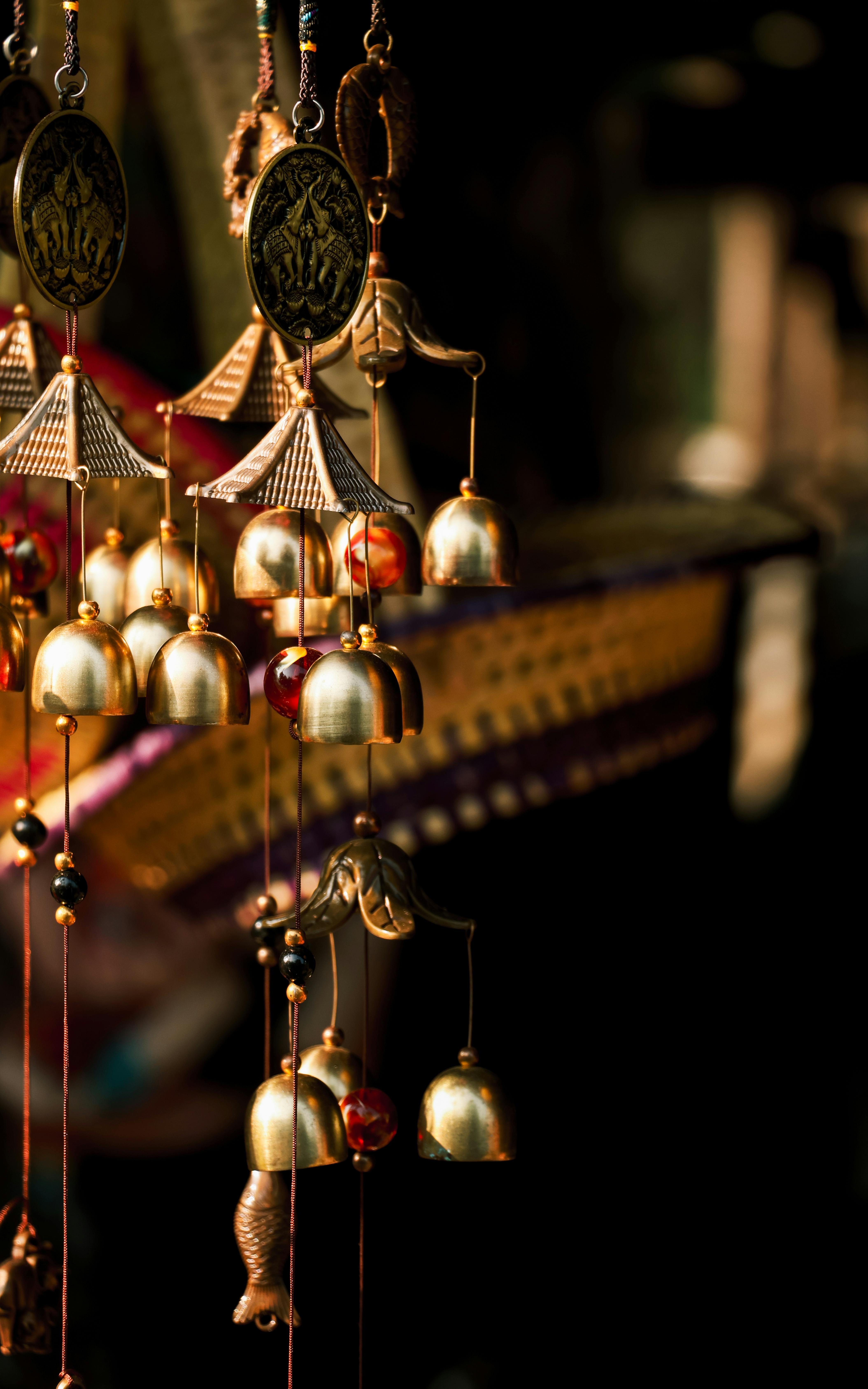Close-up of Hanging Brass Bells in Warm Light · Free Stock Photo